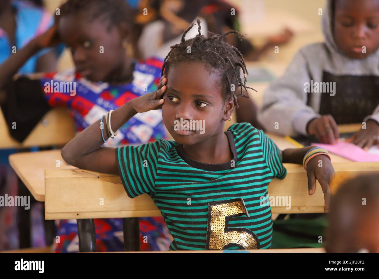 TORO, SENEGAL - FEB 4: A schoolgirl in her classroom at her desk at ...