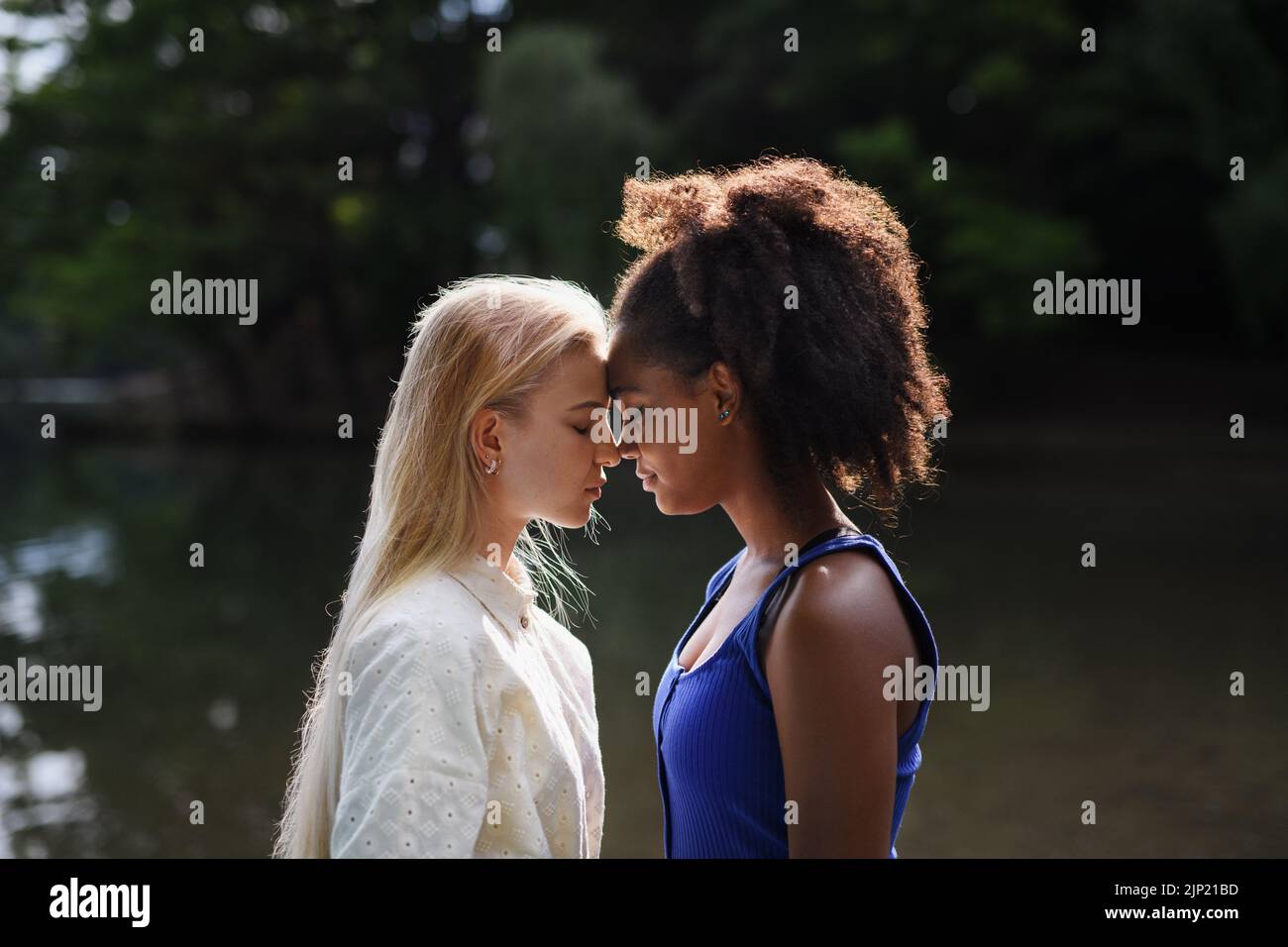 Young women spending time together in nature, near lake, concept of ...