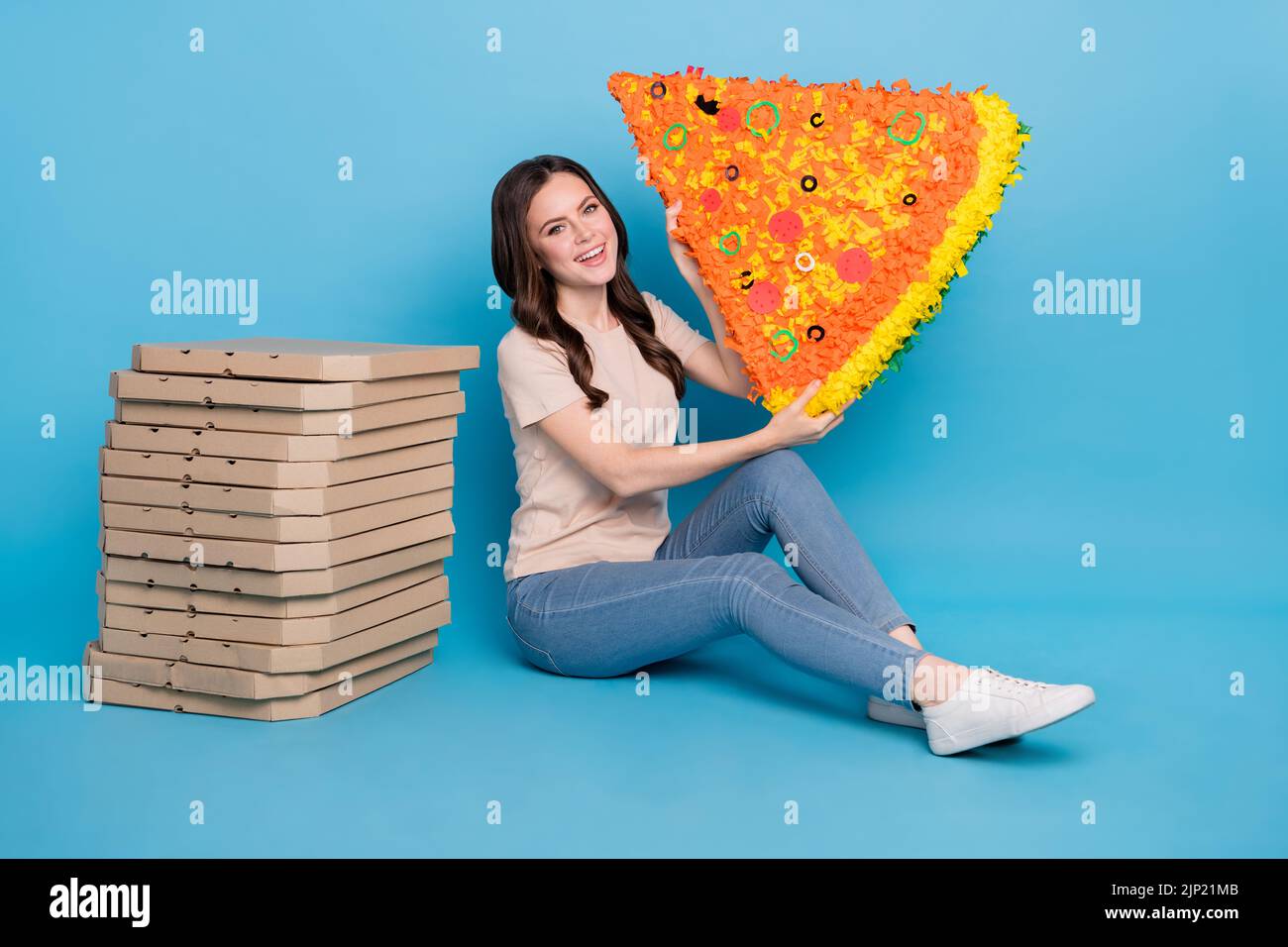 Full body photo of lovely young lady enjoying huge slice of yummy pizza ...