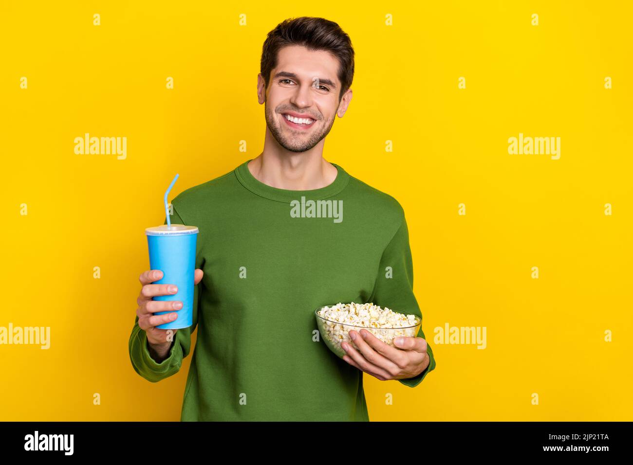 Photo of sweet charming guy dressed green pullover holding popcorn soda ...