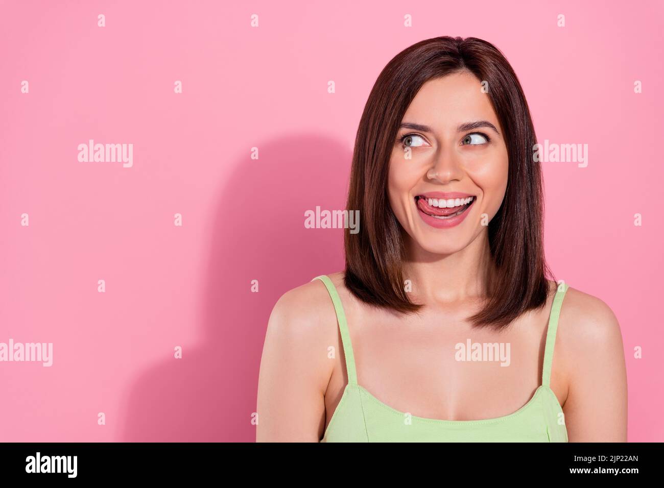 Photo of tricky shiny young lady wear green dress looking empty space ...