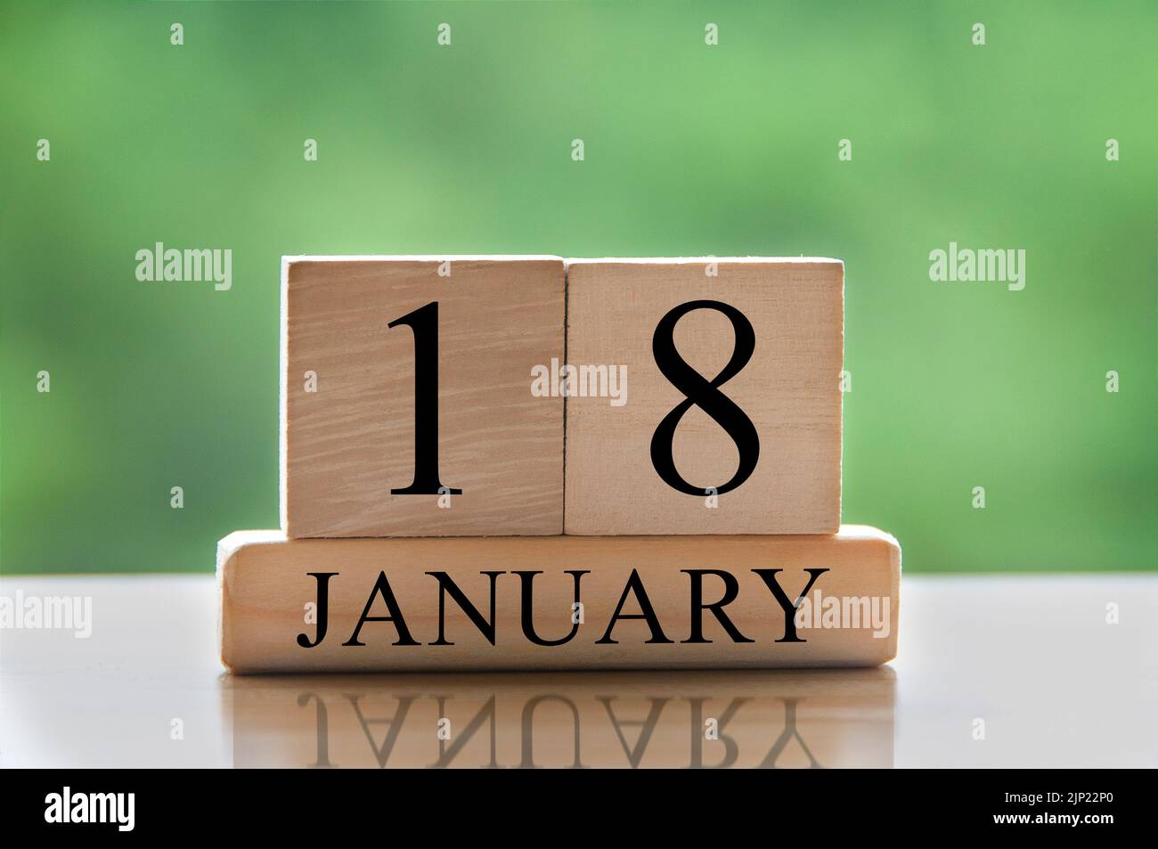 January 18 calendar date text on wooden blocks with blurred background ...