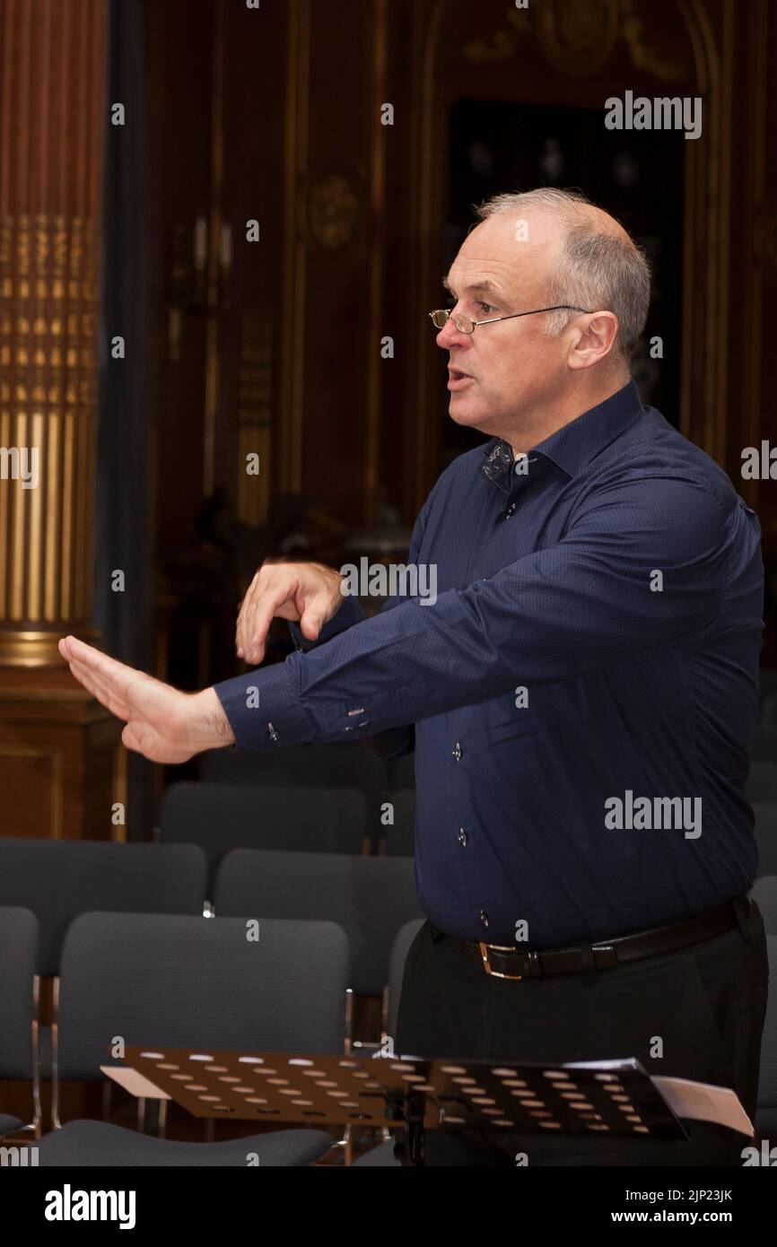 Conductor fully-focussed whilst leading a rehearsal piece for CoMA ...