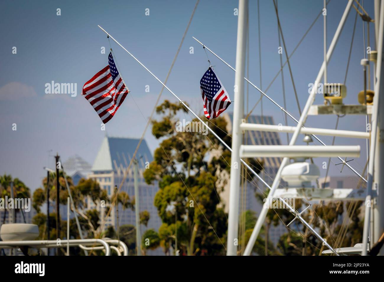 Two American flags flying on a sailboat, blowing in the wind, at ...