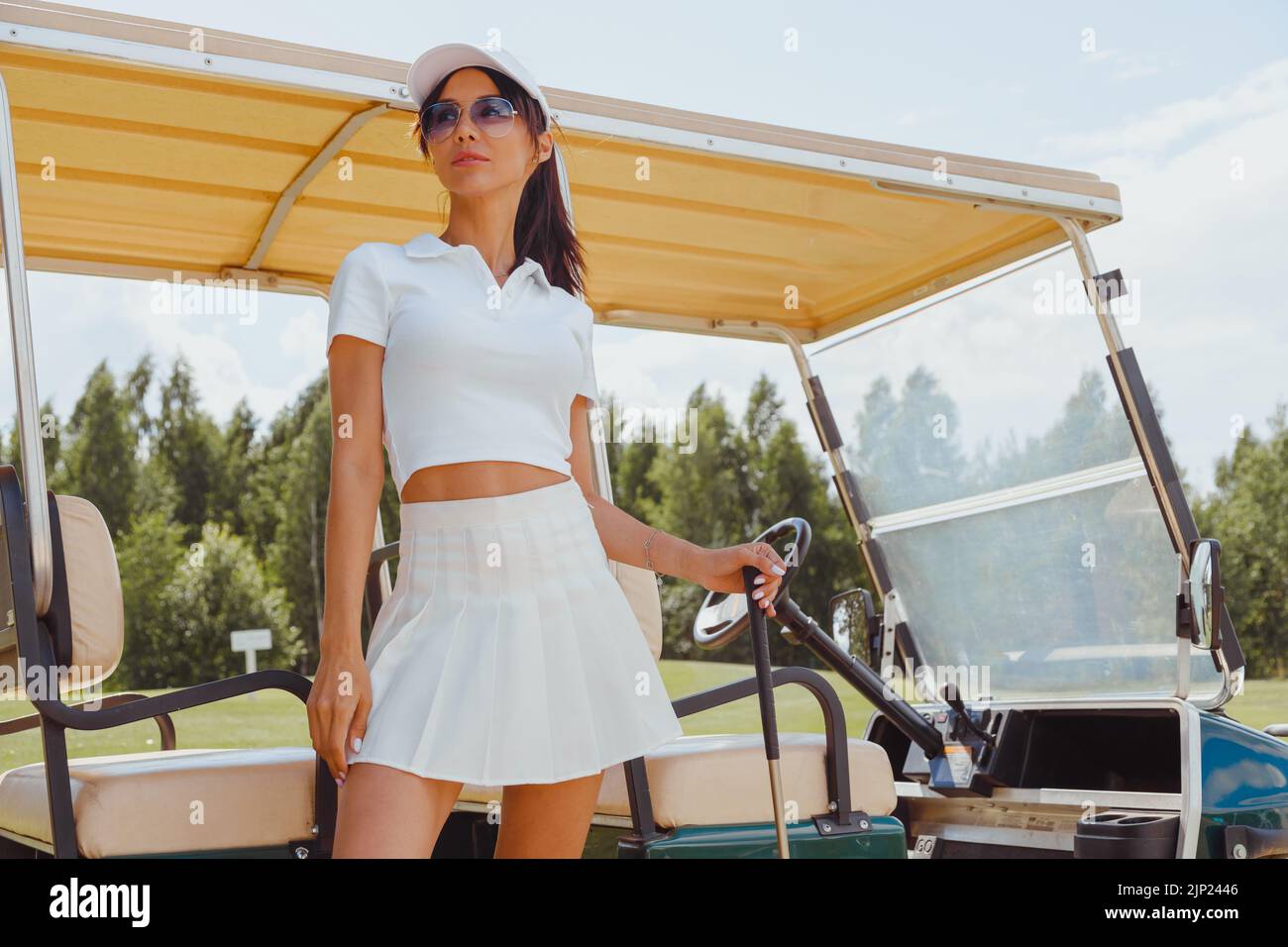 Woman golf car driver in white uniform, stand at club car Stock Photo ...
