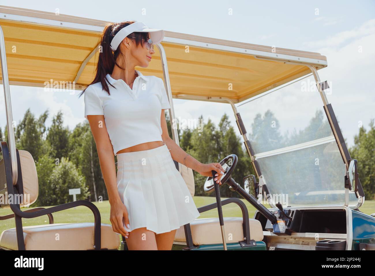 Woman golf car driver in white uniform, stand at club car Stock Photo ...
