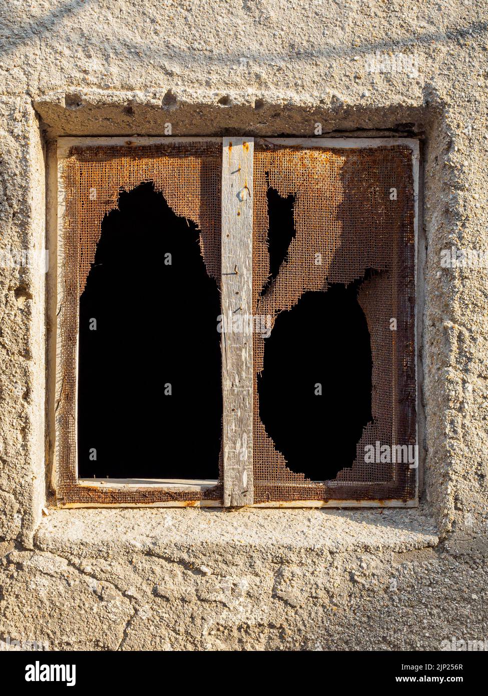 Old abandoned house window with rusty mesh Stock Photo - Alamy