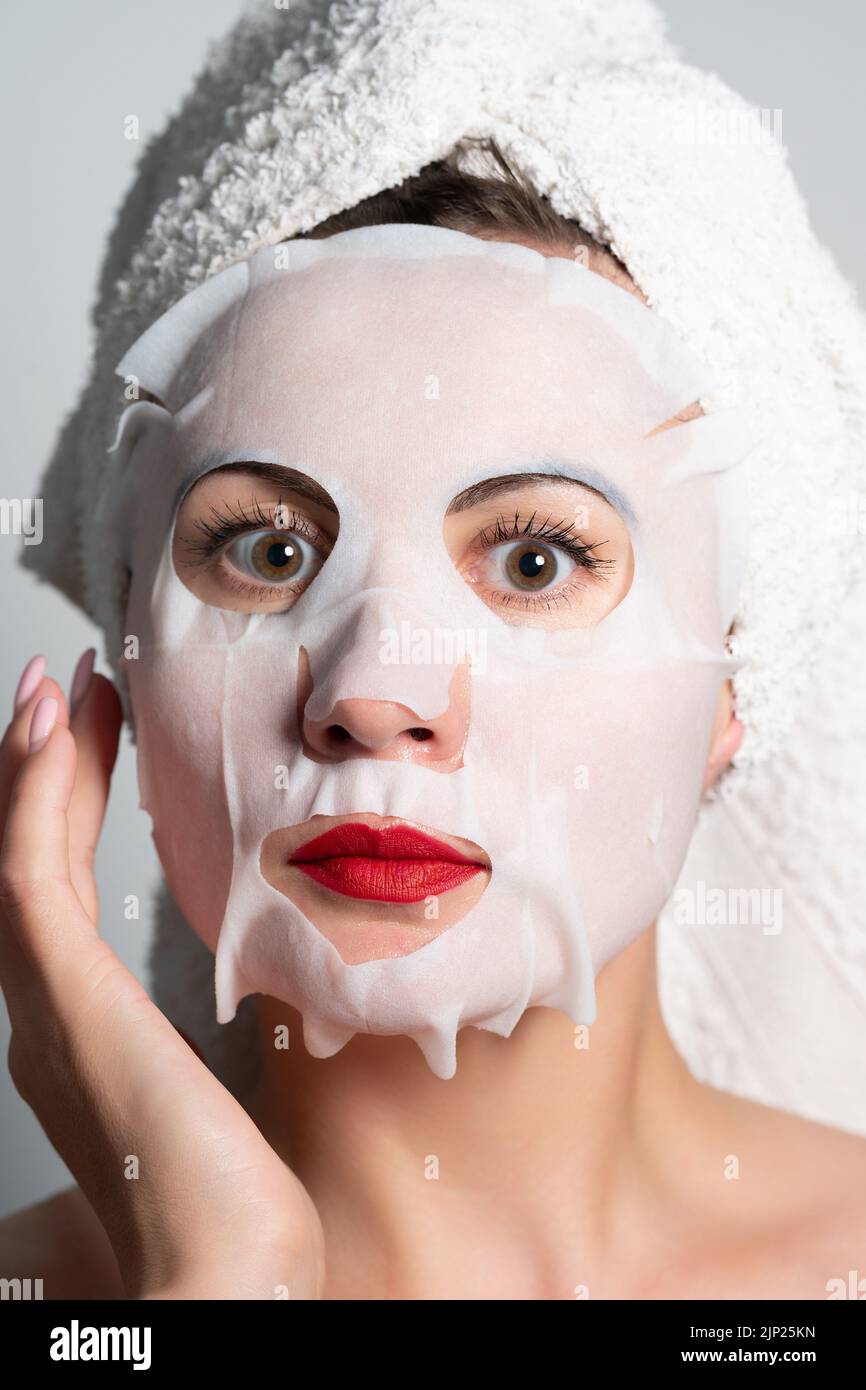 Fabric refreshing face mask, skin care, portrait of a woman with a mask ...