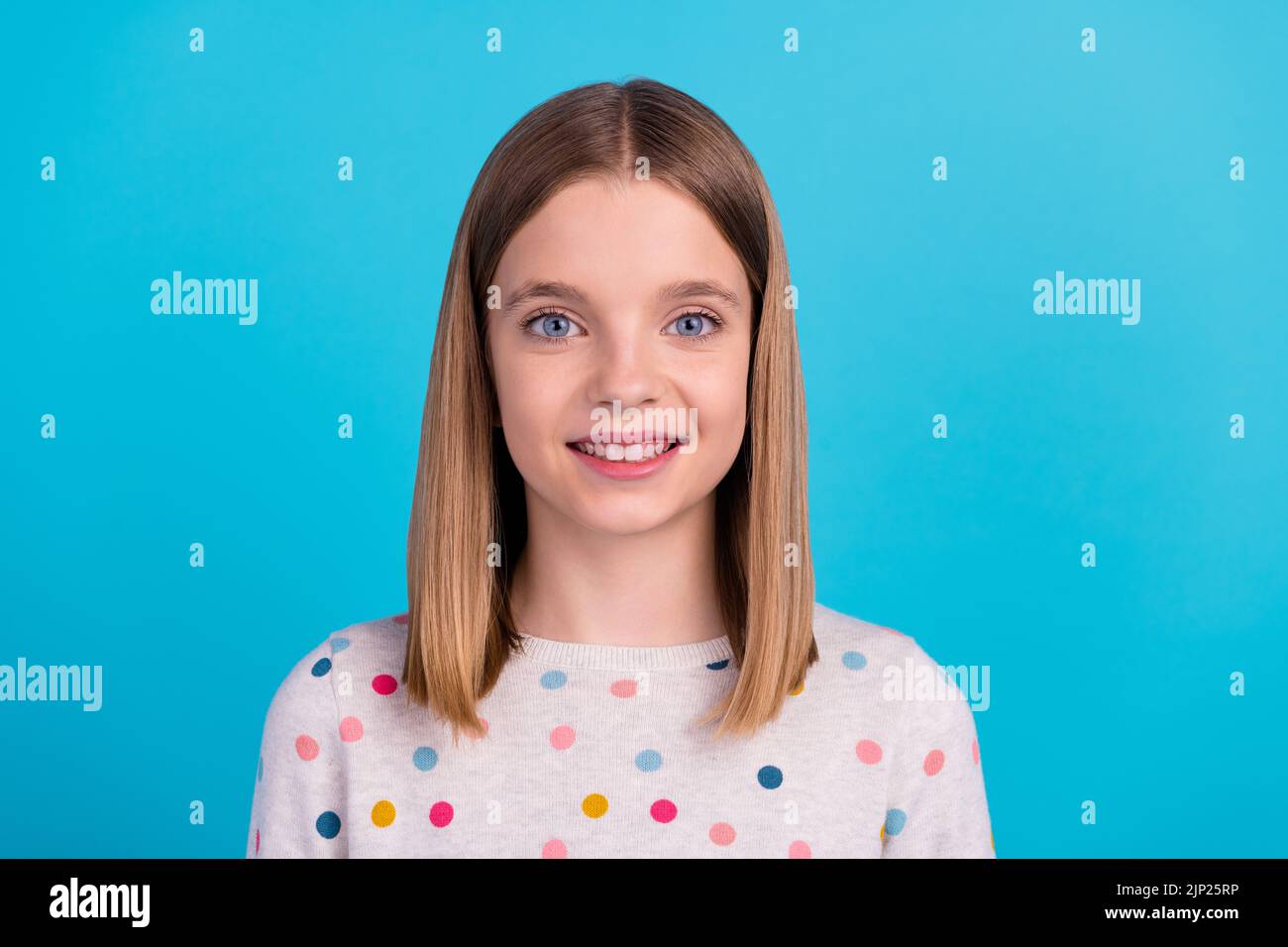 Photo of confident adorable small girl wear dotted shirt smiling ...