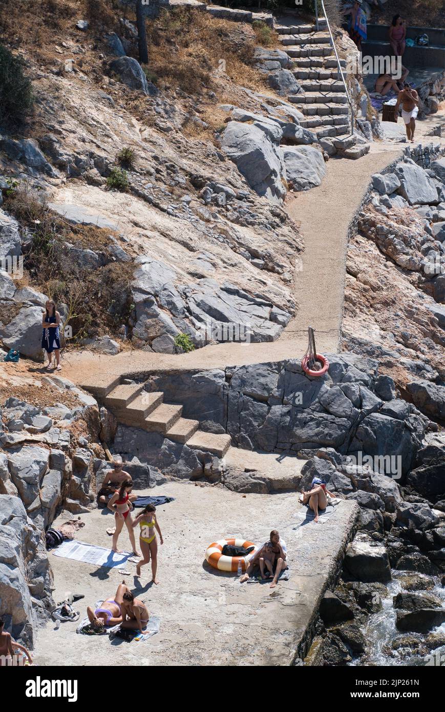 Young people sunbathing in Hydra in Greece in summer Stock Photo - Alamy