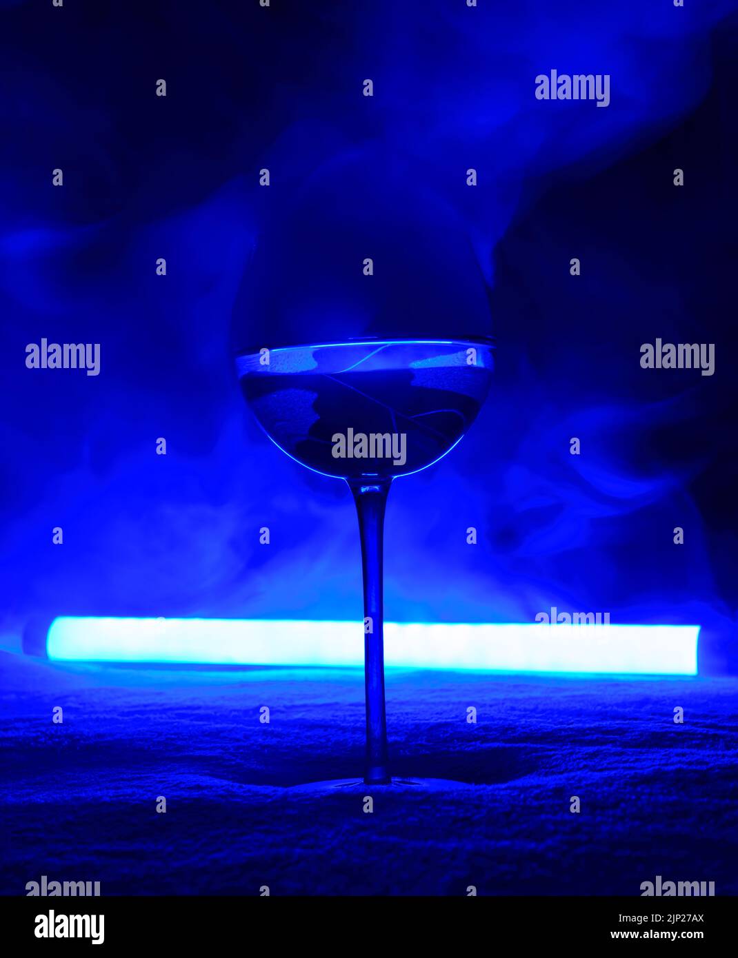 Concept of an abstract blue alcoholic cocktail in a darkness with a ...