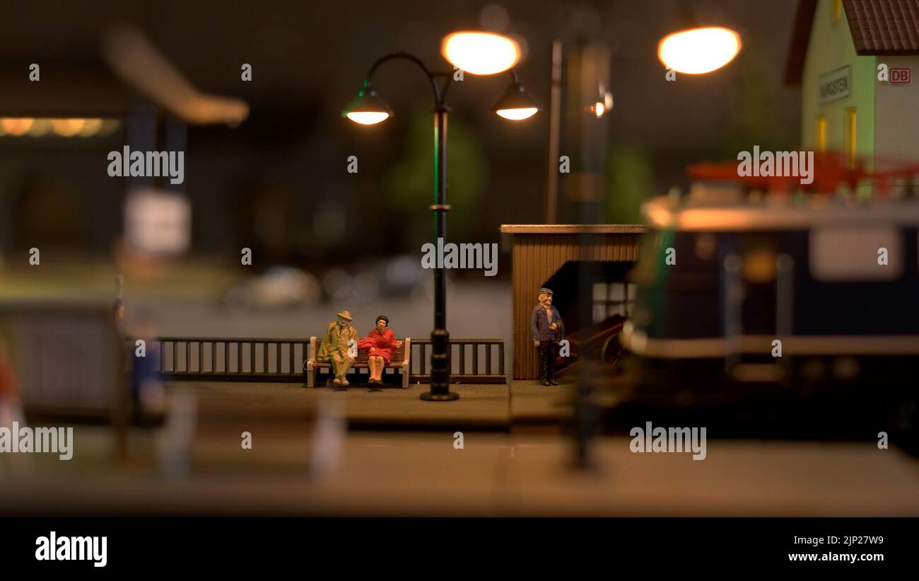 Toy diesel locomotive leaving the station. Miniature passenger train ...