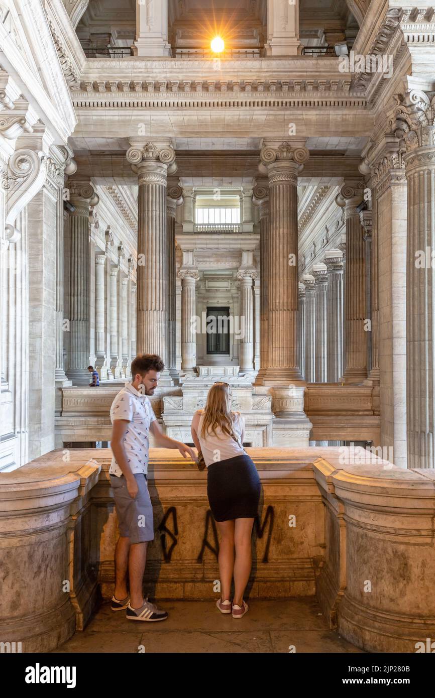 Young man staring at his girlfriend's buttocks in the Palais de Justice in Brussels Stock Photo ...