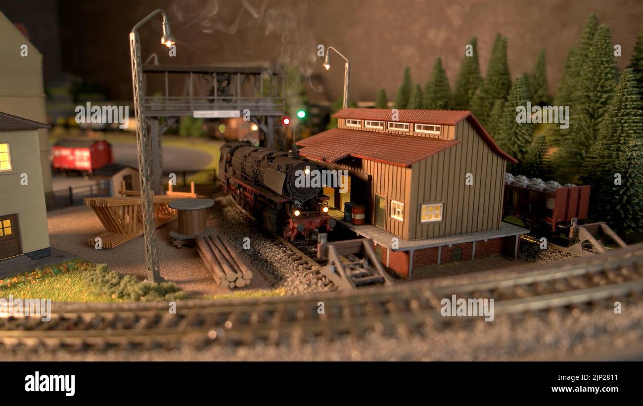 Model railway station with moving model locomotive. Toy diesel ...