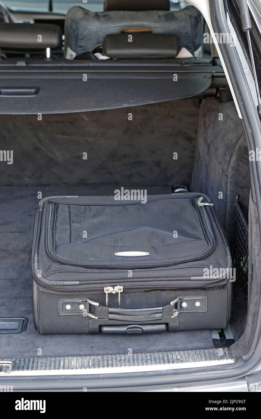 Black business luggage case in car cargo trunk Stock Photo - Alamy