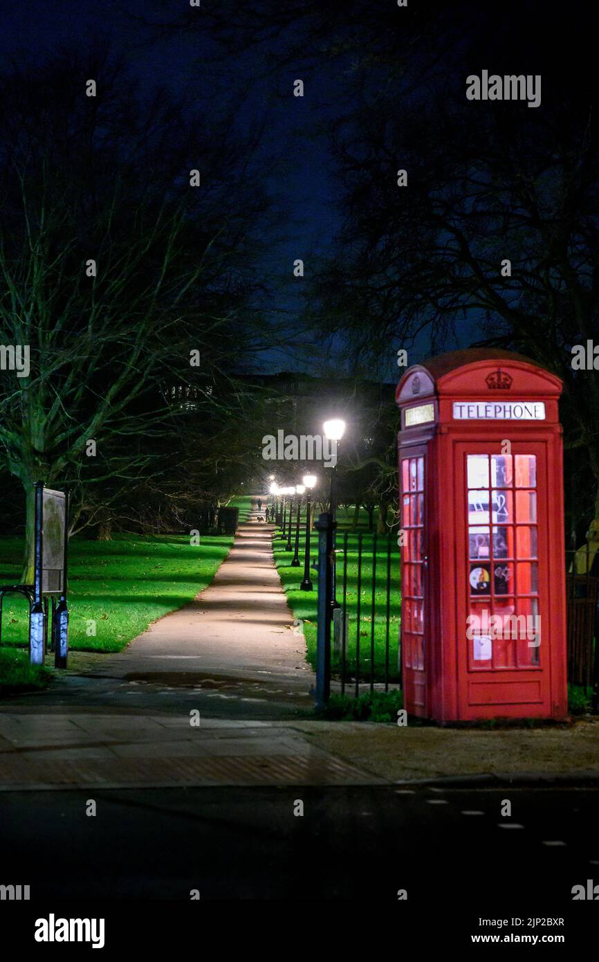 A view of London with a red phone box and a park at night Stock Photo ...
