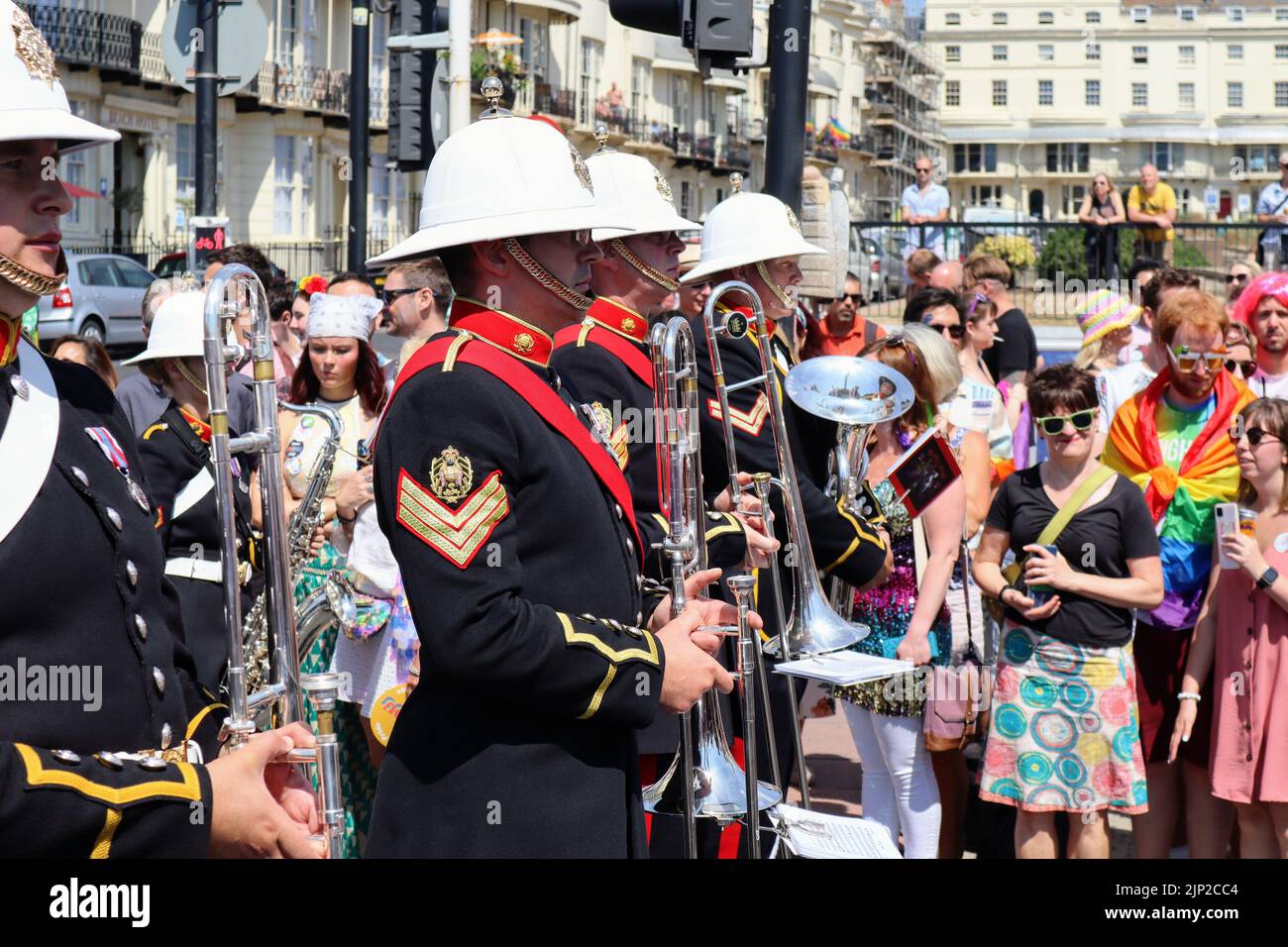 A band at Brighton Pride Parade while people are walking on the streets ...