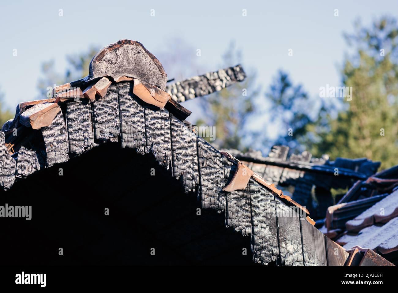 Detail of burnt wooden structure of a house after the fire blaze ...