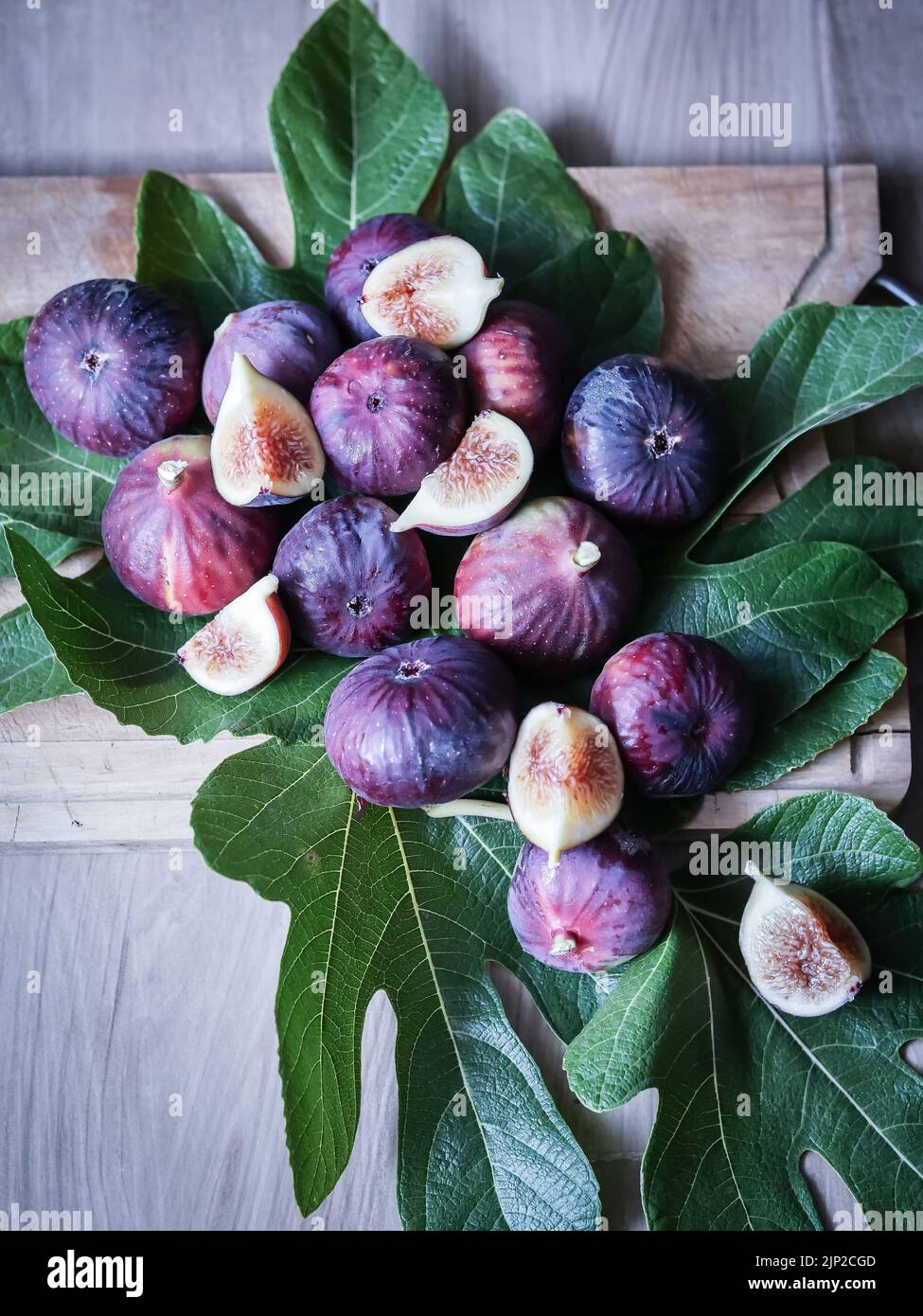 A fig fruits on a leaf in the table Stock Photo - Alamy