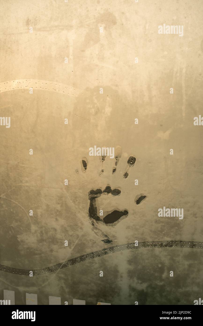 A vertical shot of a handprint on a wet glass surface Stock Photo - Alamy