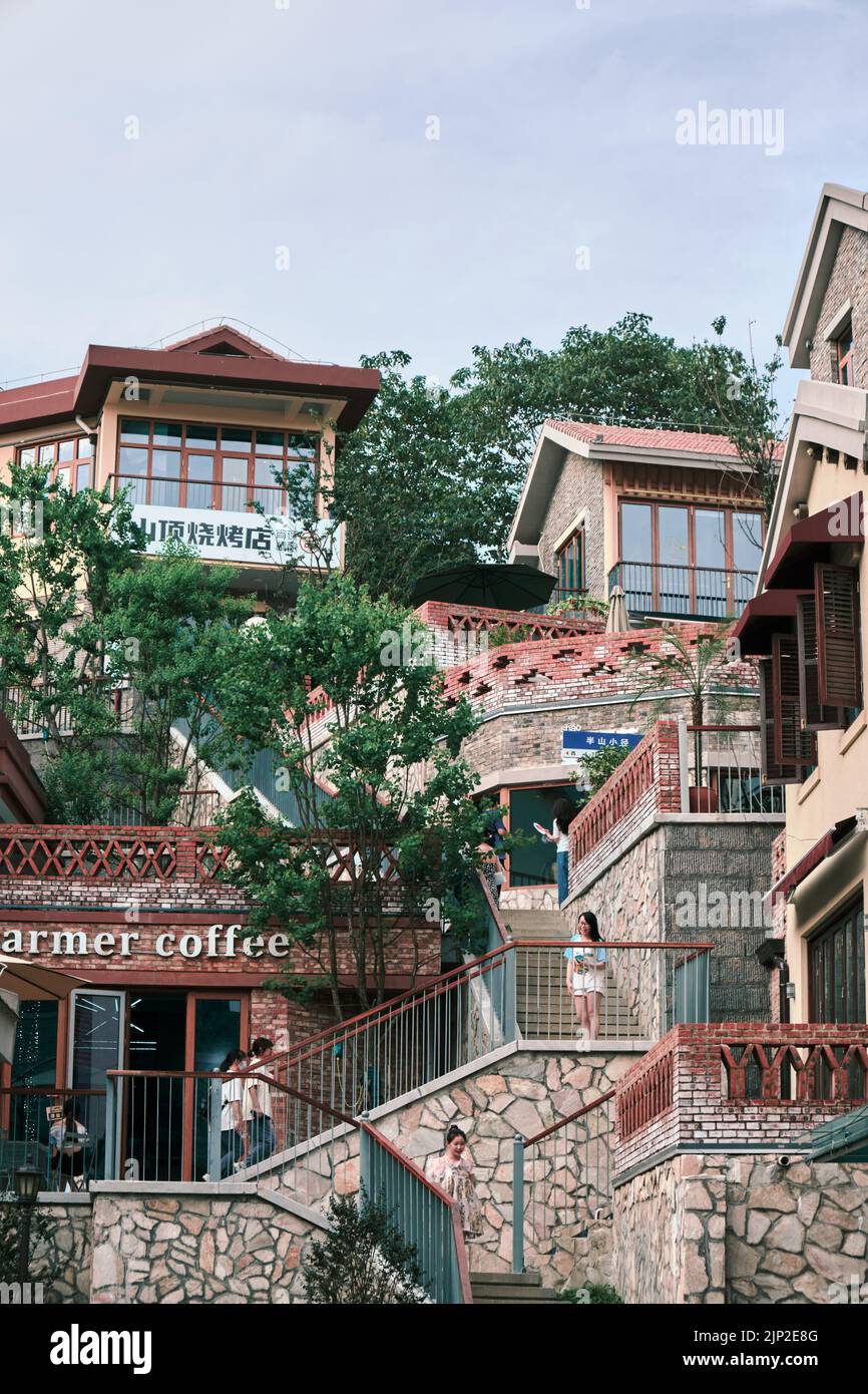 A vertical shot of Chinese traditional buildings built by the mountain ...