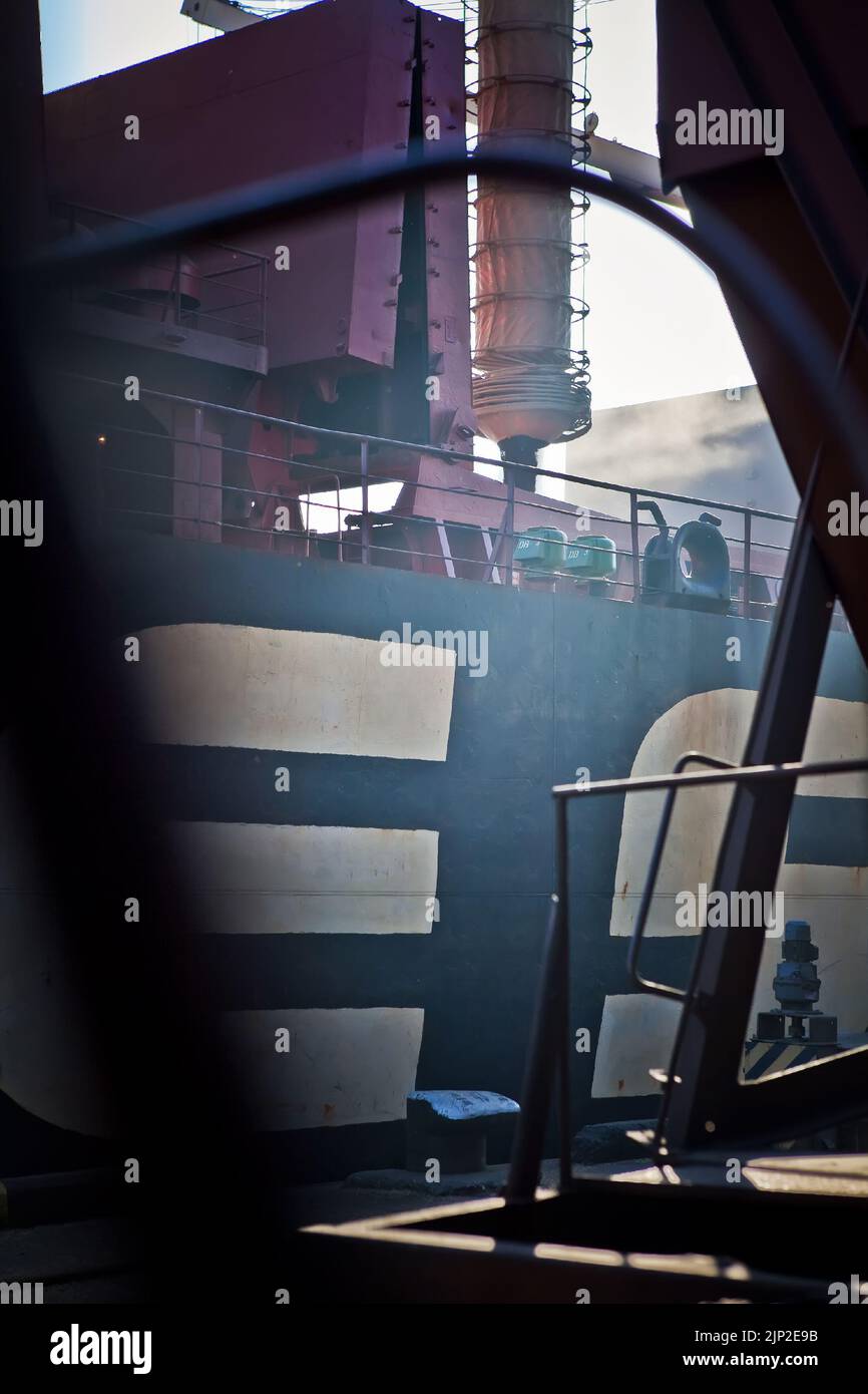 Loading grain into holds of sea cargo vessel in seaport from grain ...