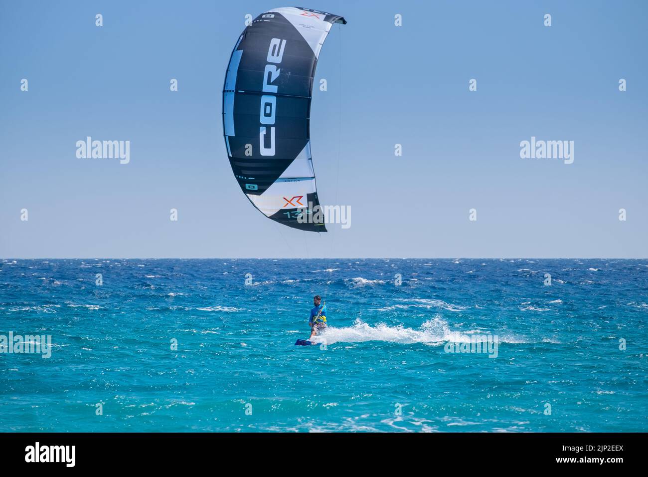 Man kitesurfing in the sea of Agiokampos beach , Greece Stock Photo - Alamy