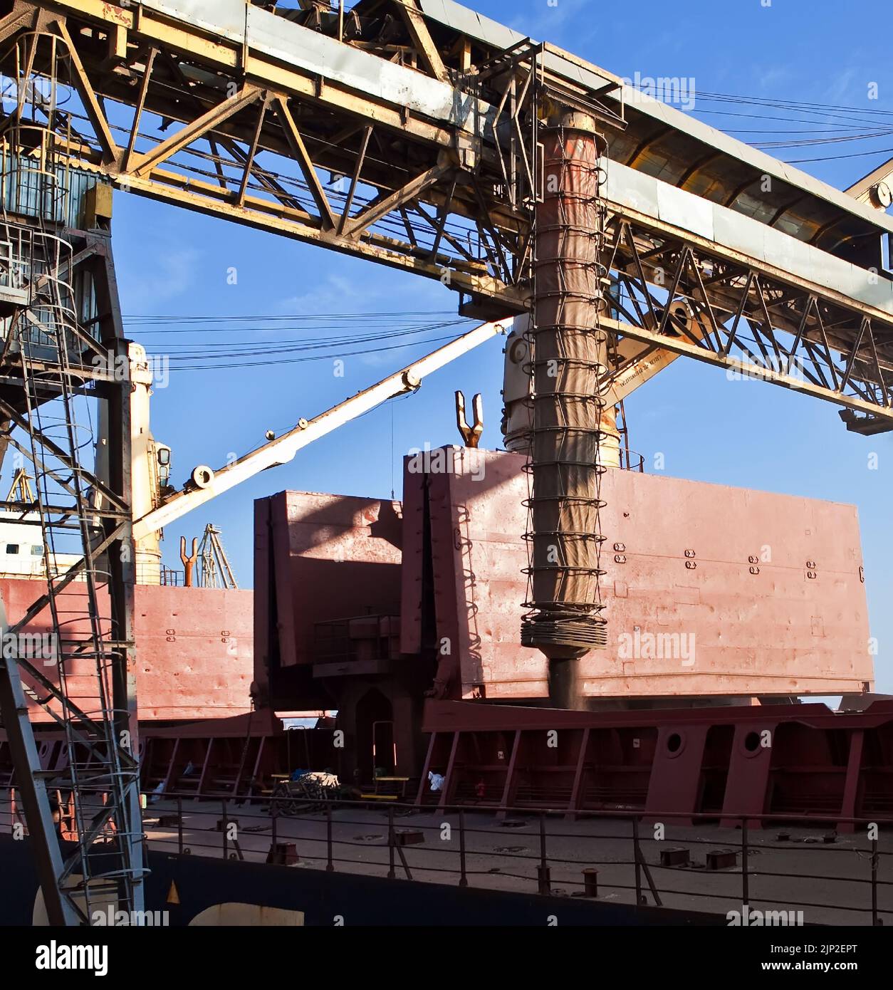 Loading grain into holds of sea cargo vessel in seaport from grain ...