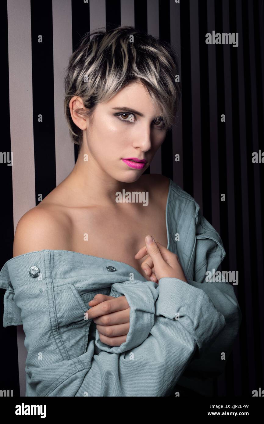 A female model with makeup posing in a studio Stock Photo - Alamy