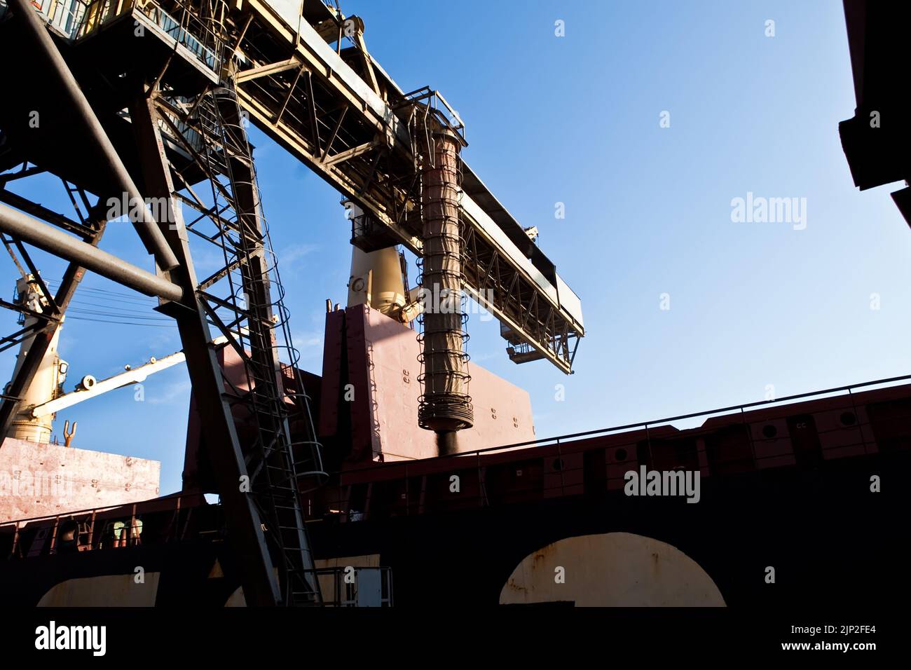 Loading grain into holds of sea cargo vessel in seaport from grain ...