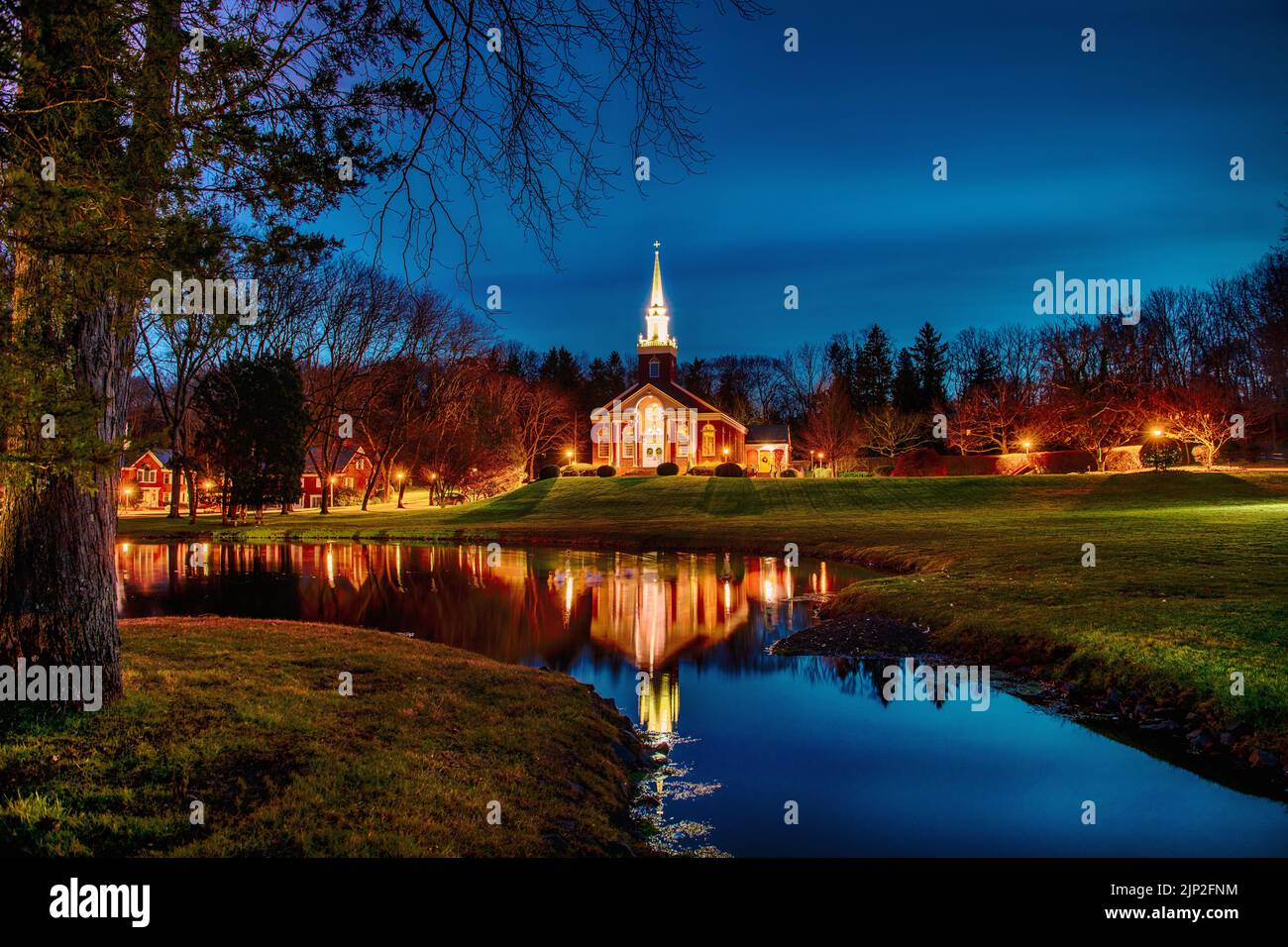 A beautiful cathedral with lit lamps in the evening in front of the ...