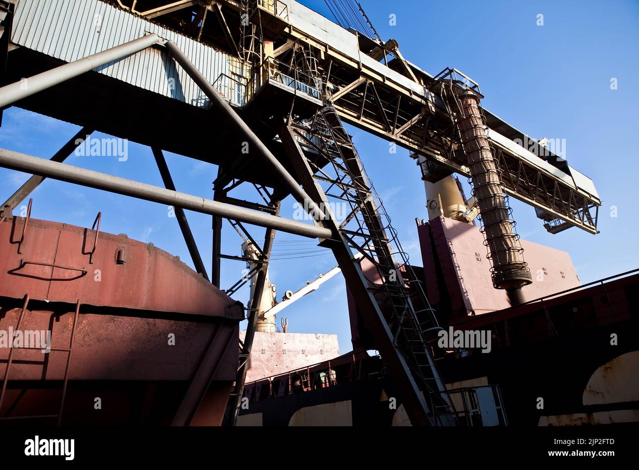 Loading grain into holds of sea cargo vessel in seaport from grain ...