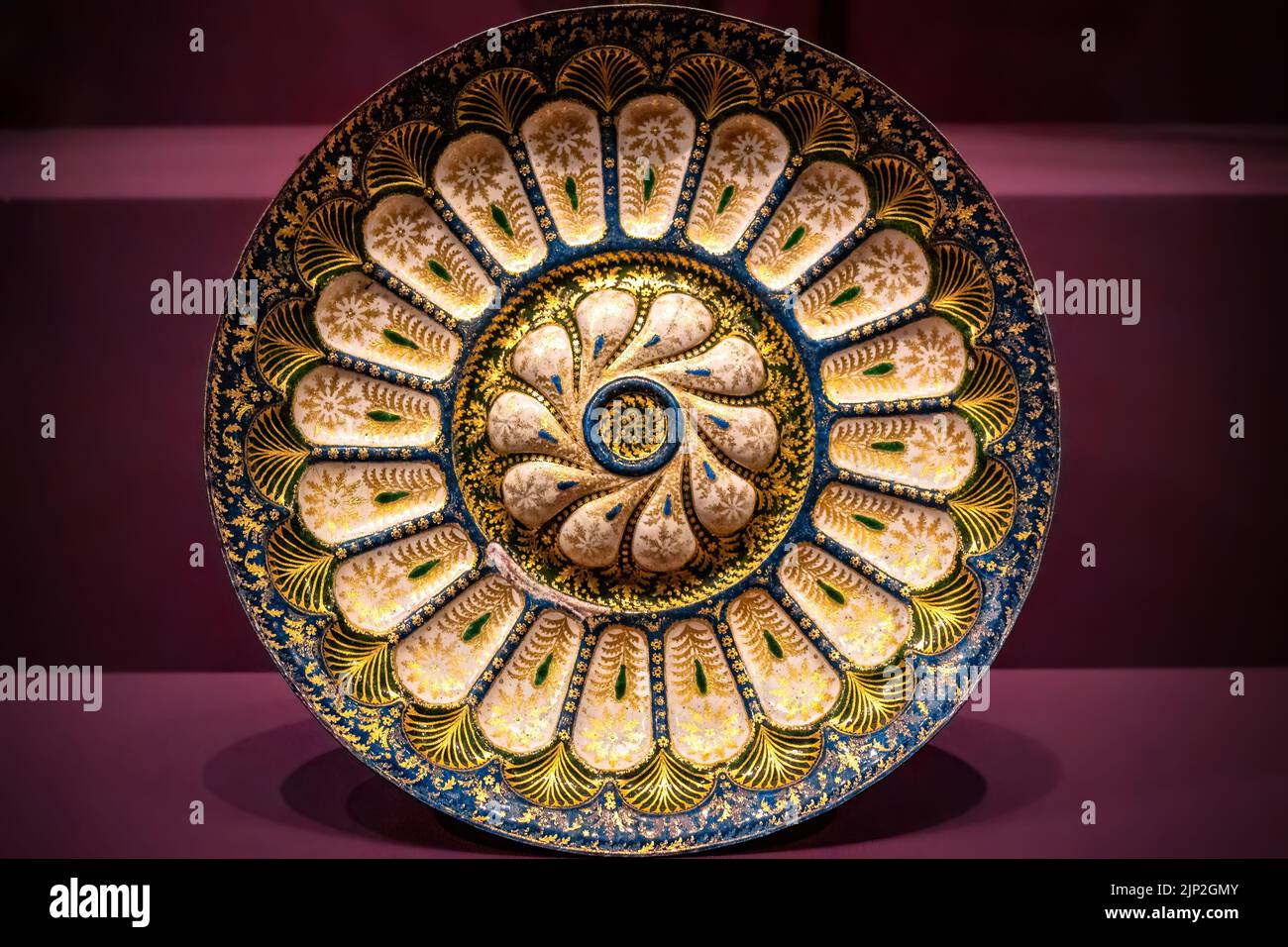 A luxurious old enamelled and gilded plate with elaborate decorations ...