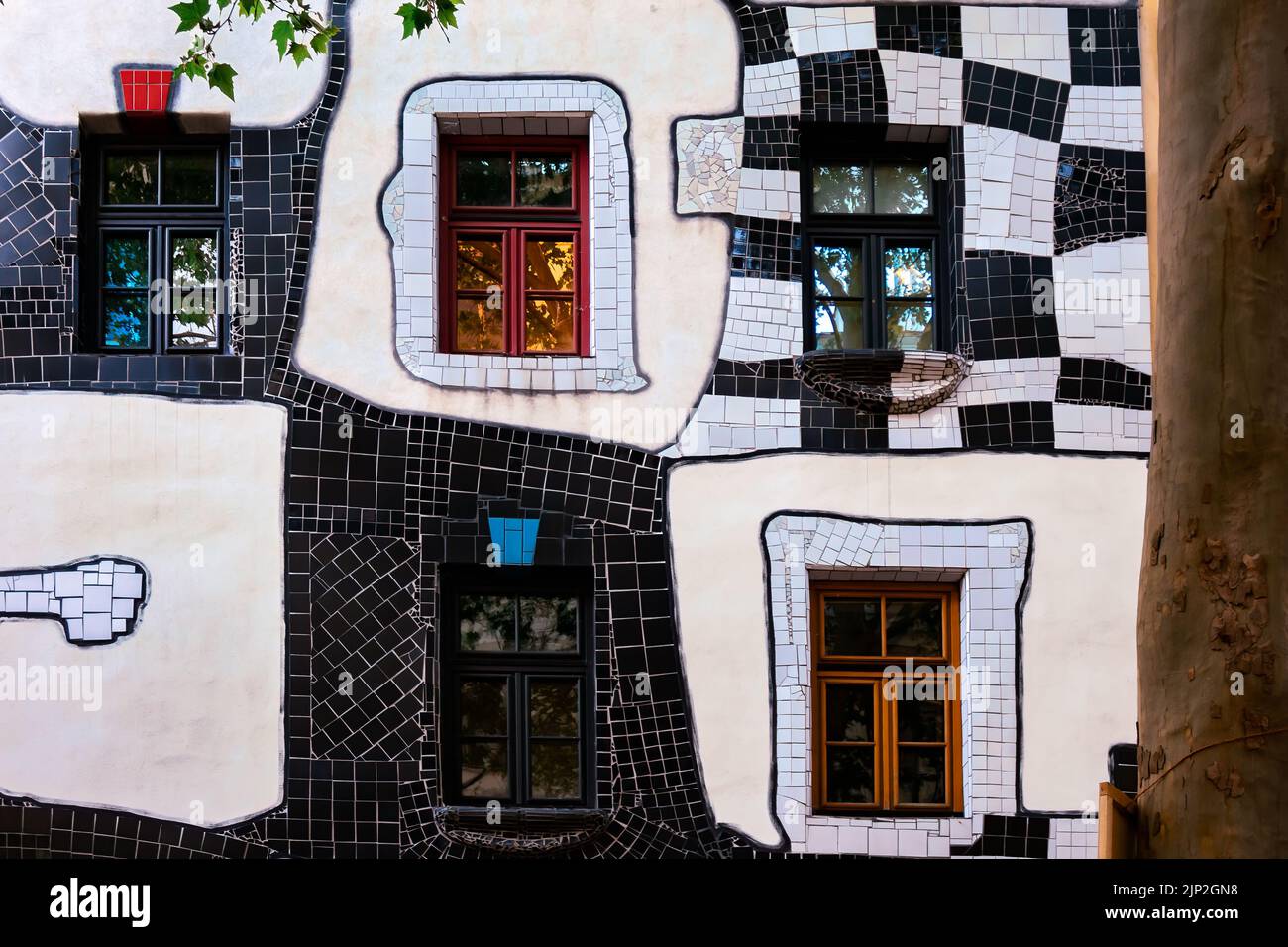 An abstractly painted black and white wall of the Hundertwasser House ...