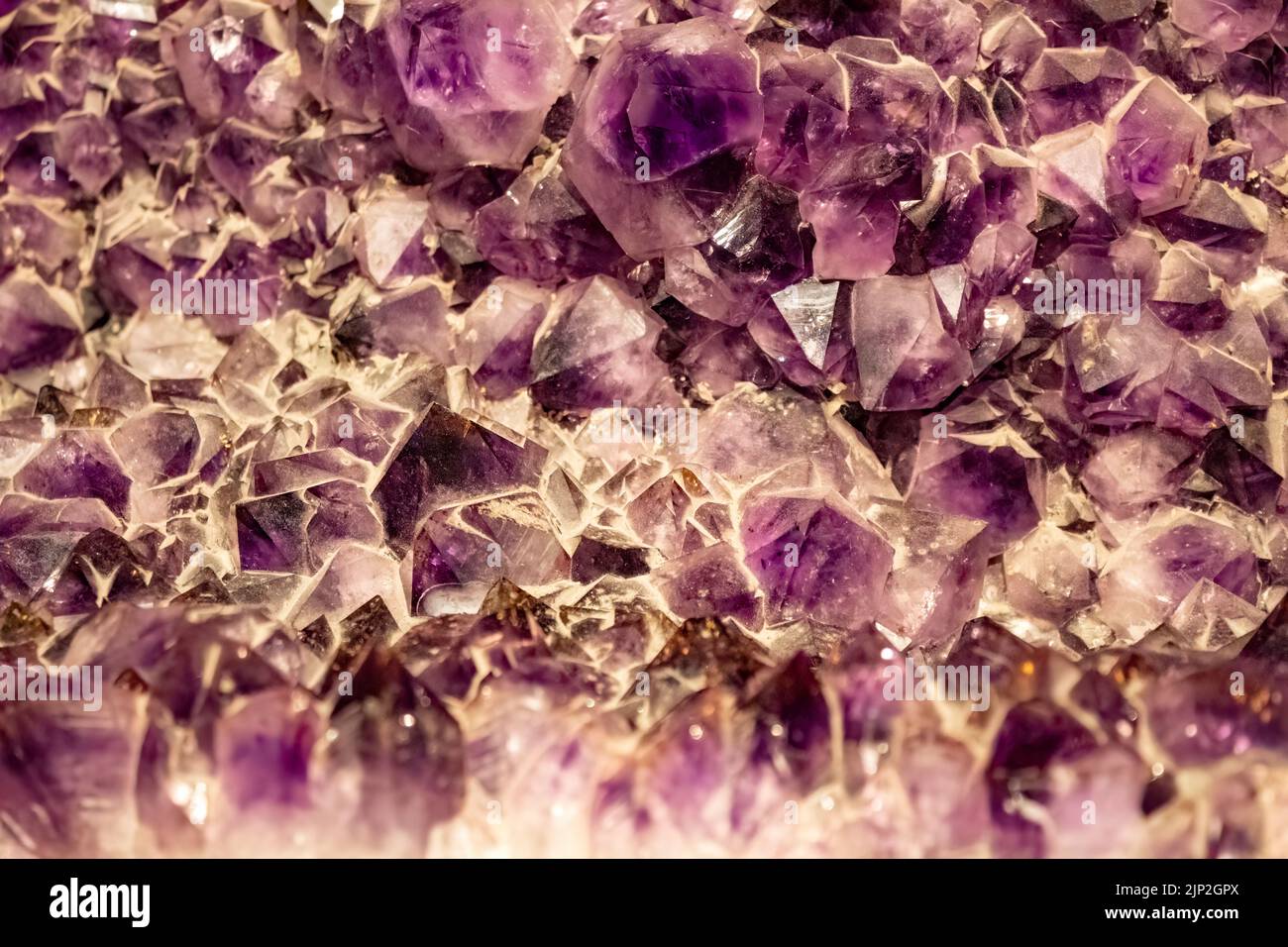 A pile of tiny purple quartz crystals that look like amethysts heaped ...