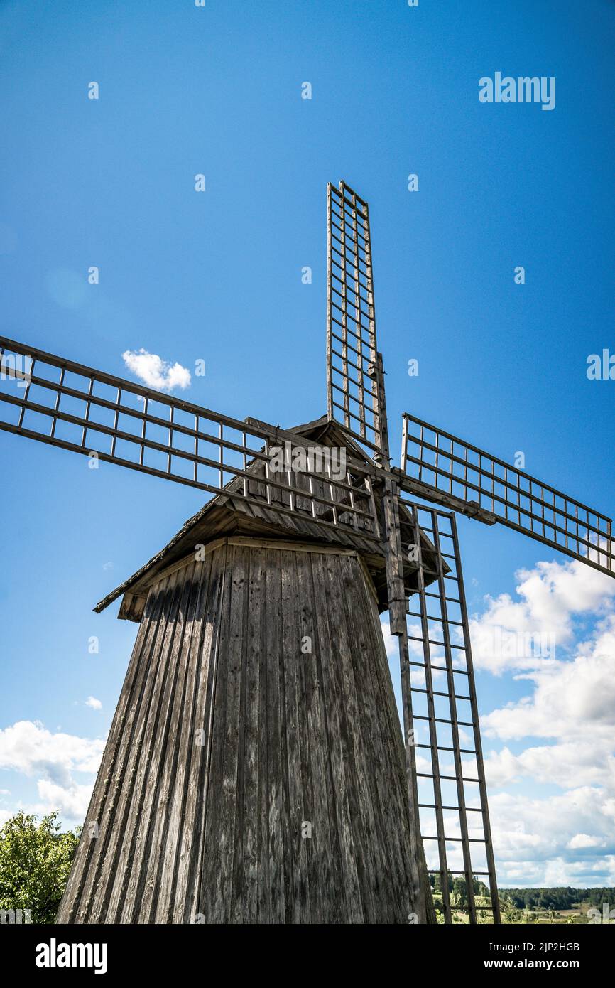 wooden windmill close-up with large blades with a beautiful sunny sky ...