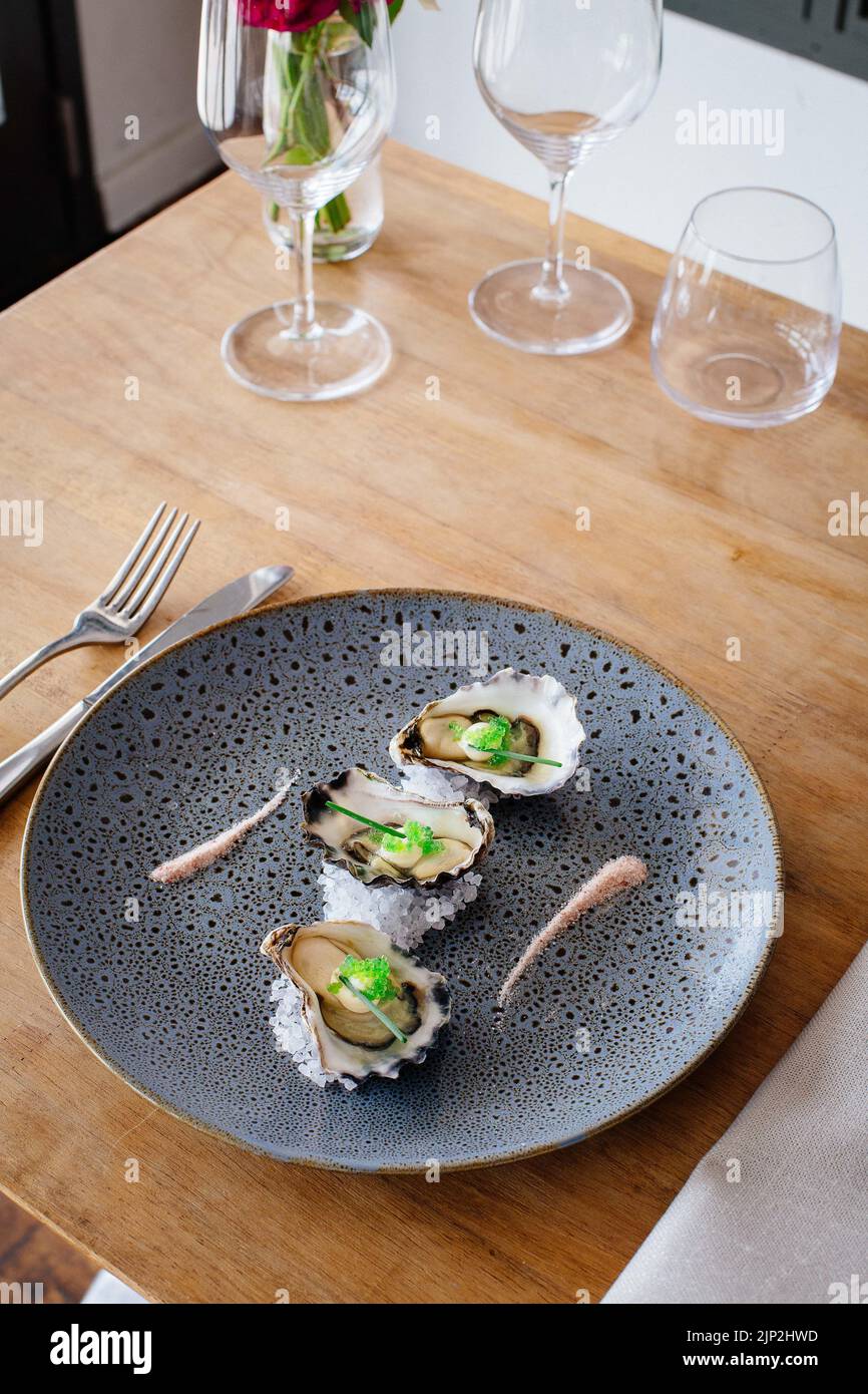A Gourmet Oysters a la natural with wasabi roe on a table Stock Photo ...