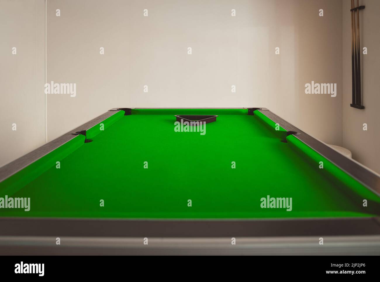 A closeup of a billiards table placed in an empty room Stock Photo - Alamy