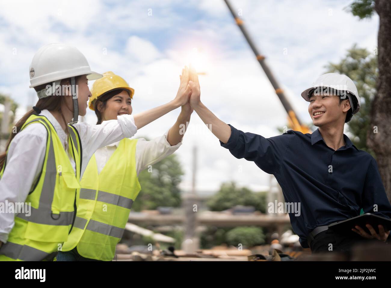 Engineers people join hands to build successful projects. Teamwork ...