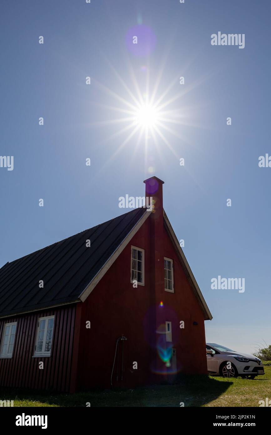 A summer house with sun right above and a clear blue sky Stock Photo ...