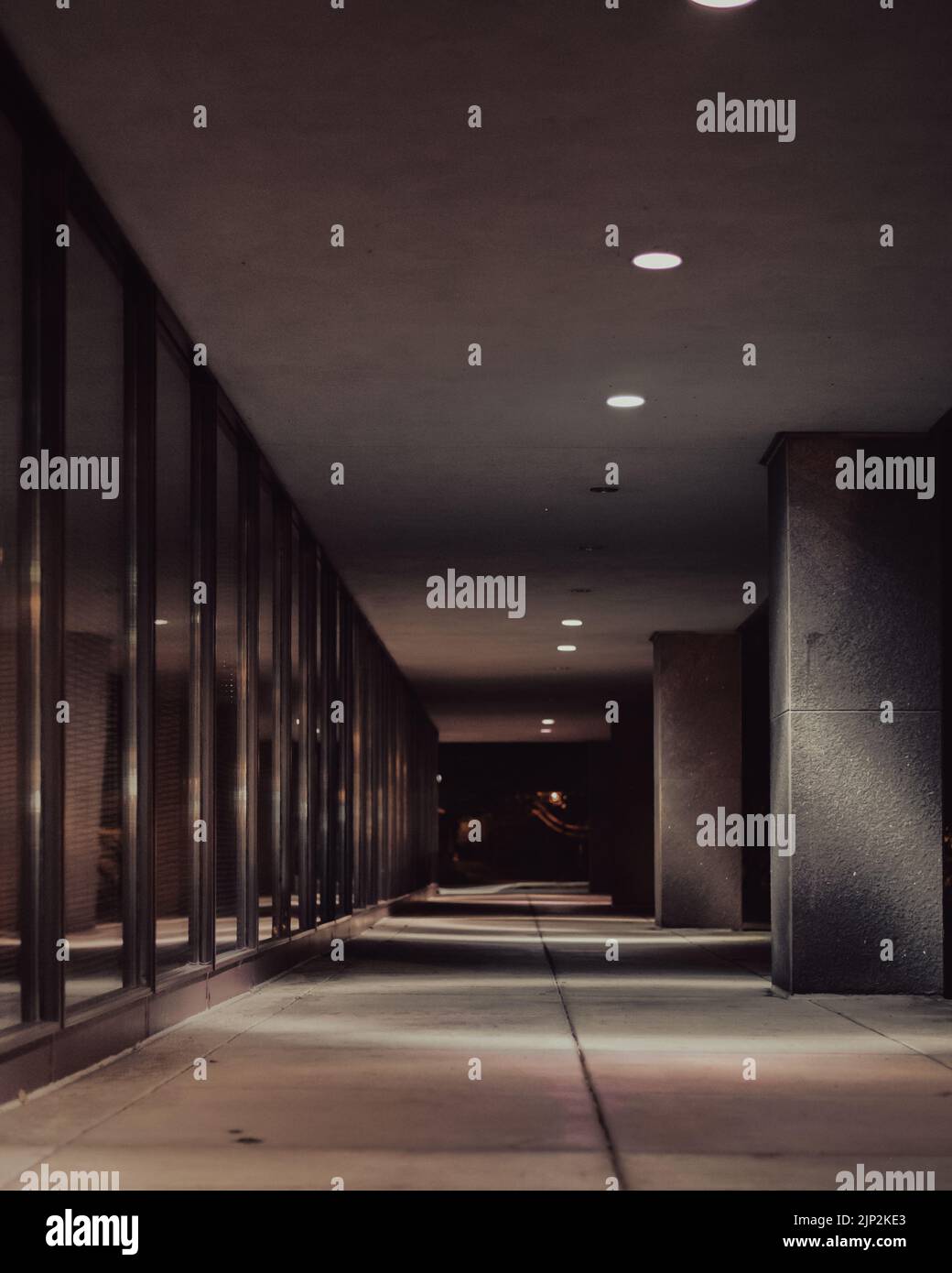 A vertical shot of an empty corridor of a building during night Stock ...