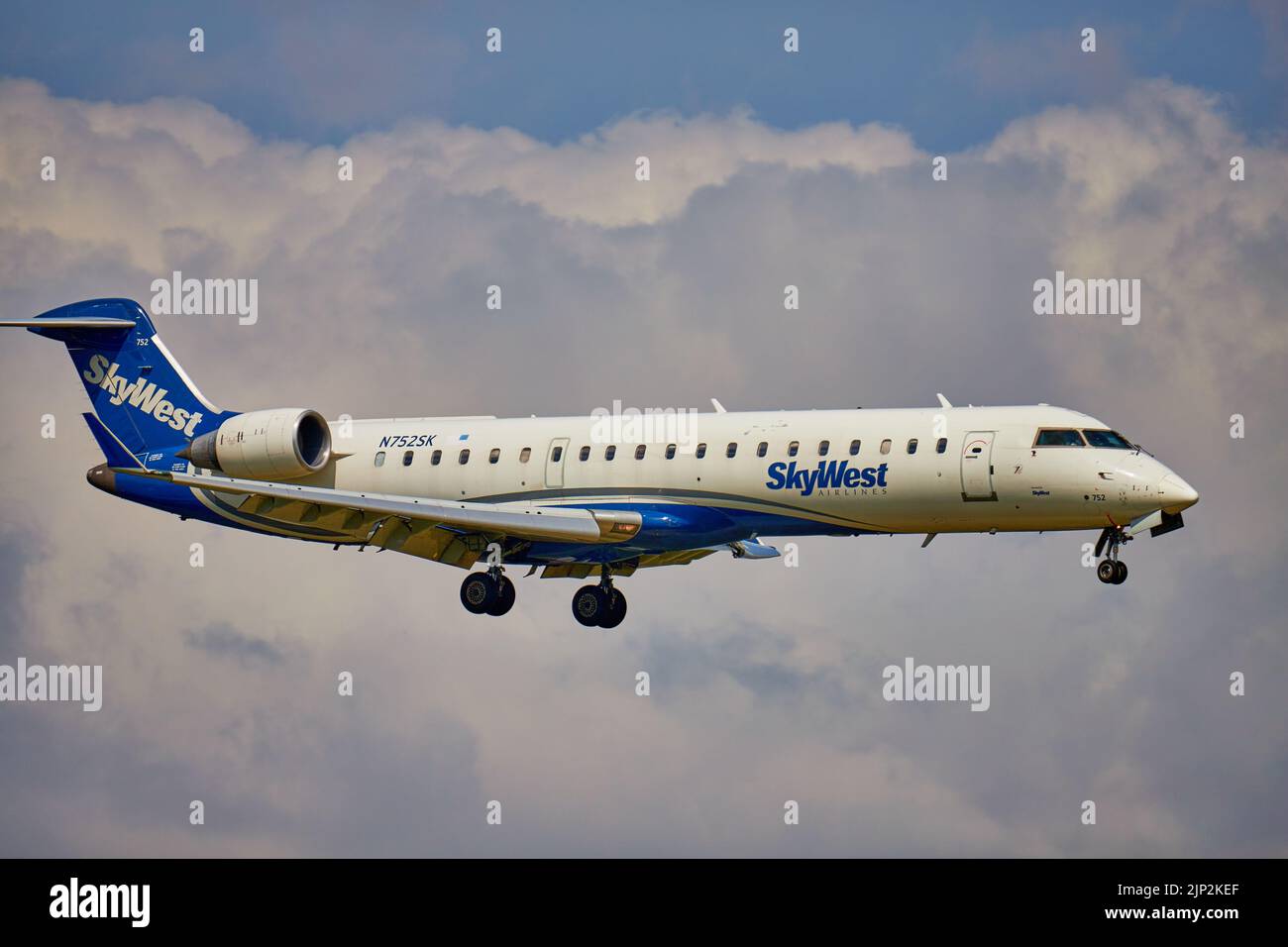 The Skywest aircraft flying in a cloudy sky Stock Photo - Alamy
