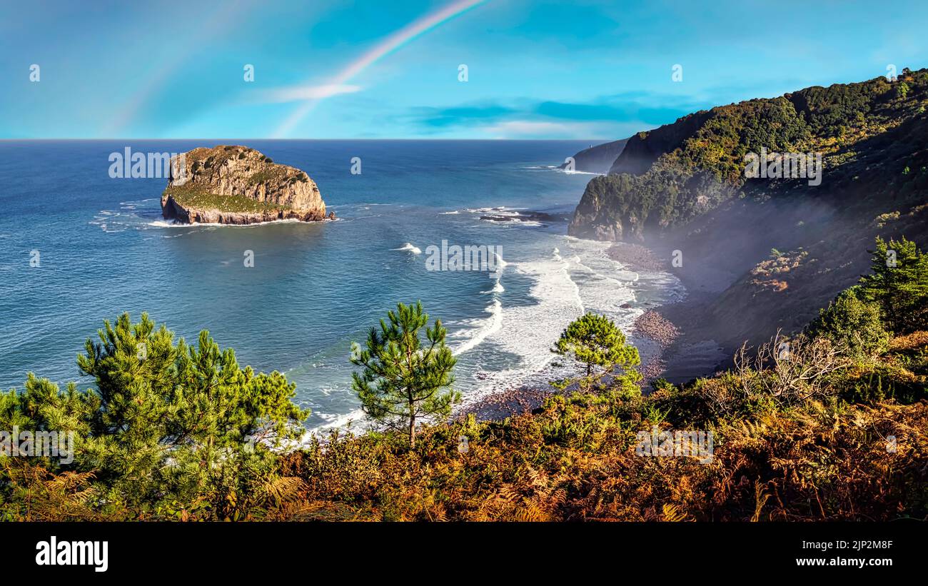 Seascape view of a deserted beach washed by waves with an islet in the ...