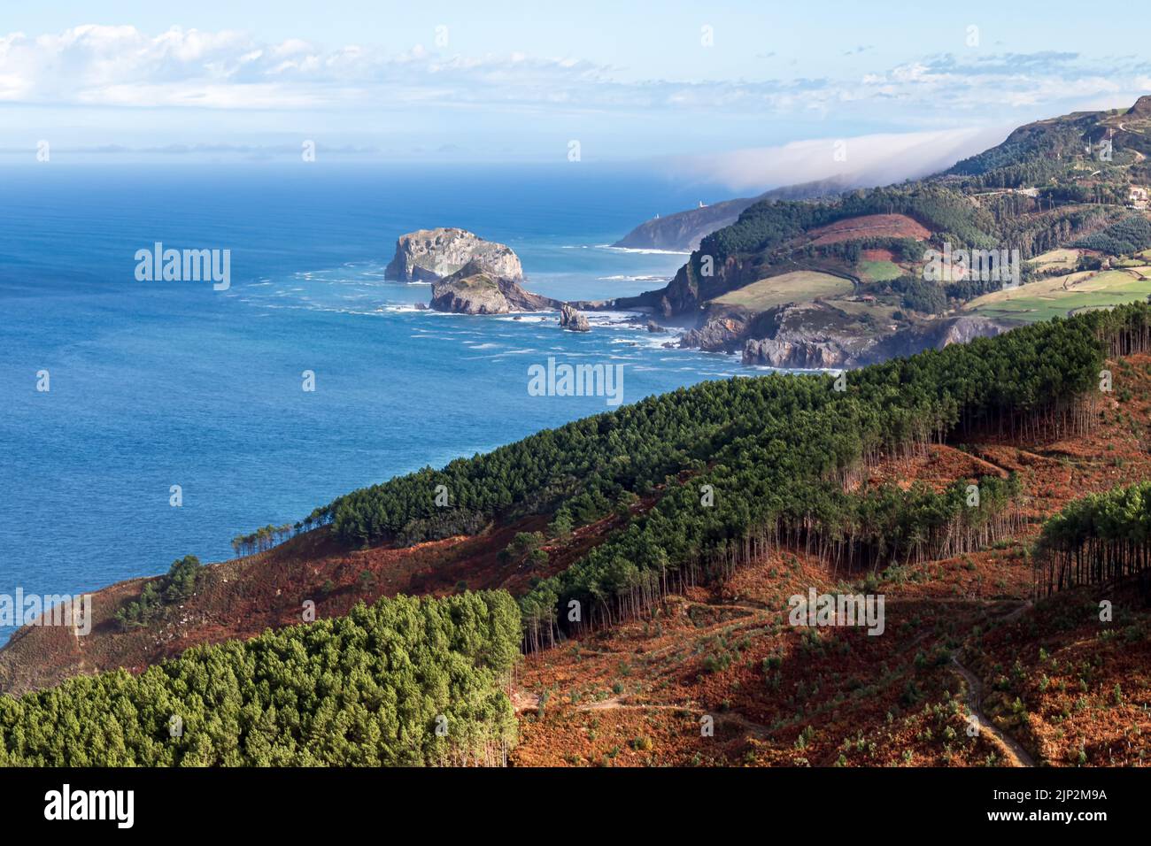 View of the seascape of a beach and rock cliffs with the sea fading to ...