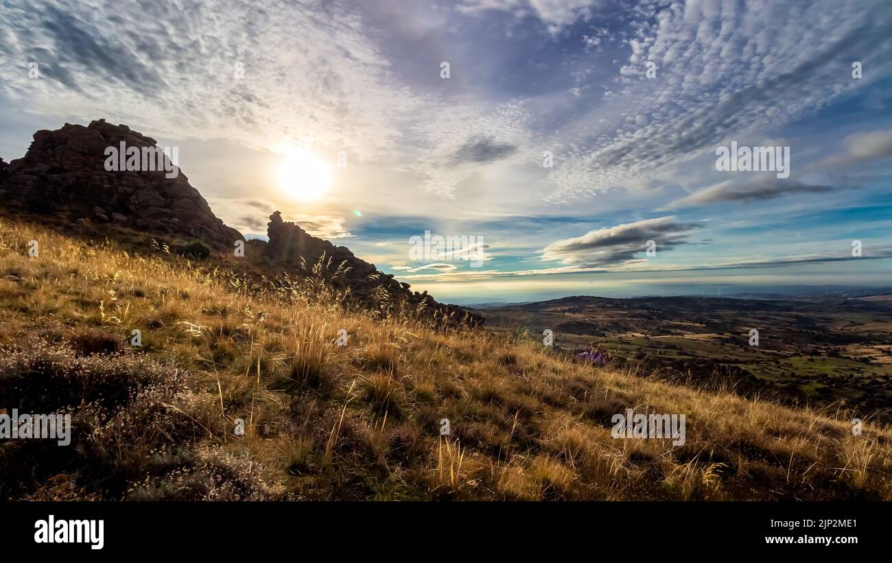 Dramatic dark mountain Madrid landscape with clouds and sun in front ...