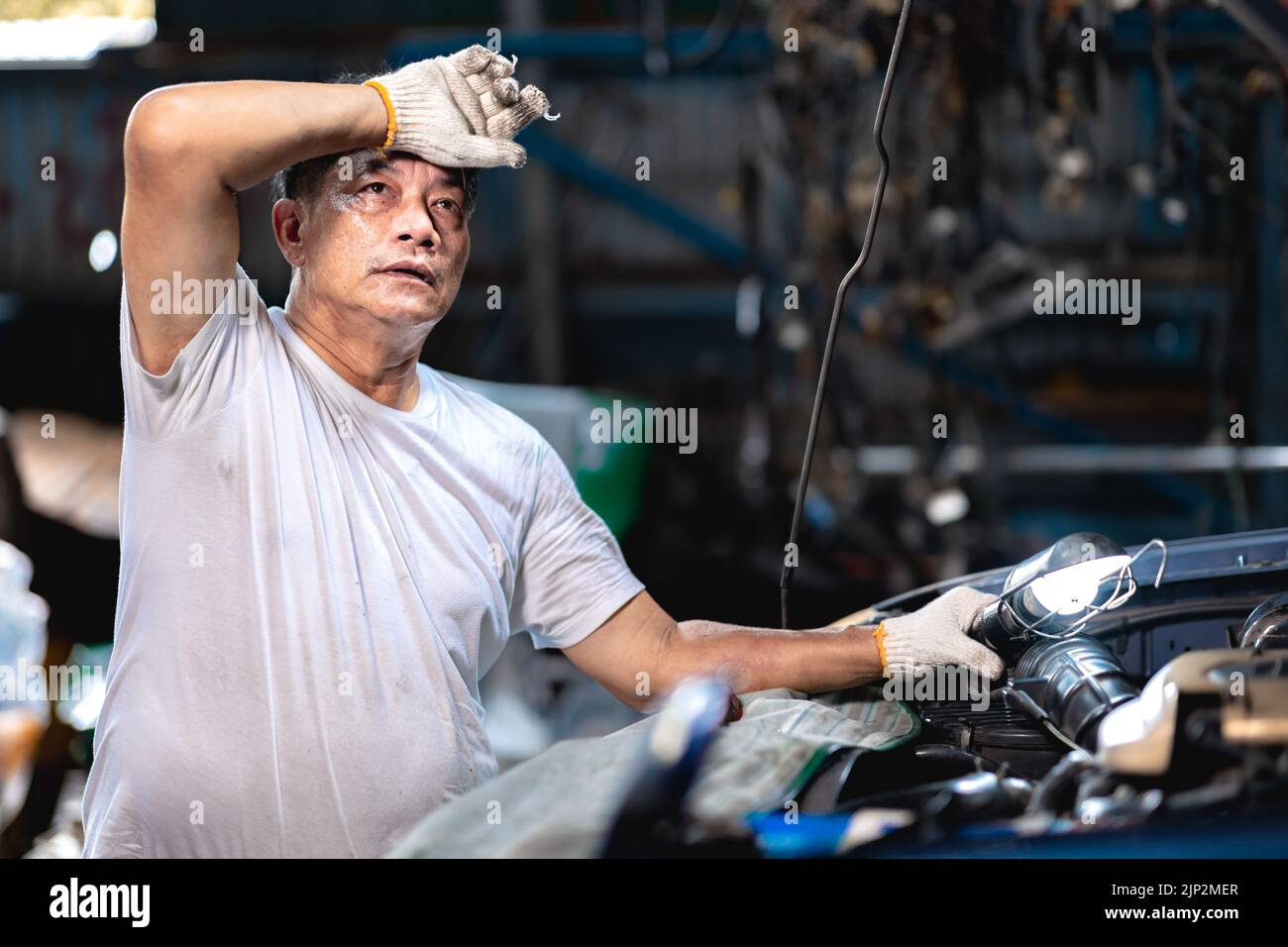 mechanic worker in garage auto service tired stressed hardwork fatigue ...