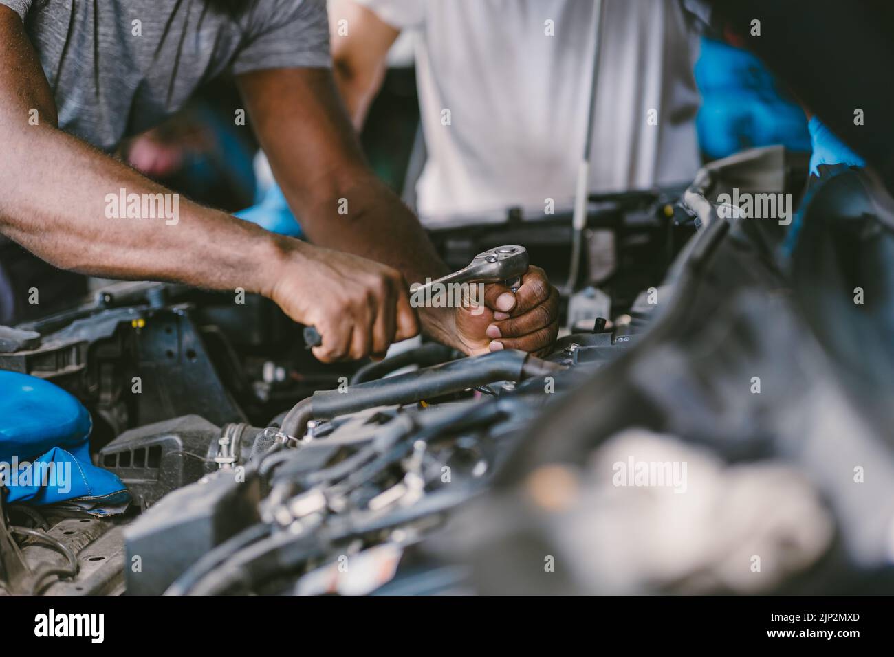 closeup mechanic hand using tool fix service car underhood engine oil ...