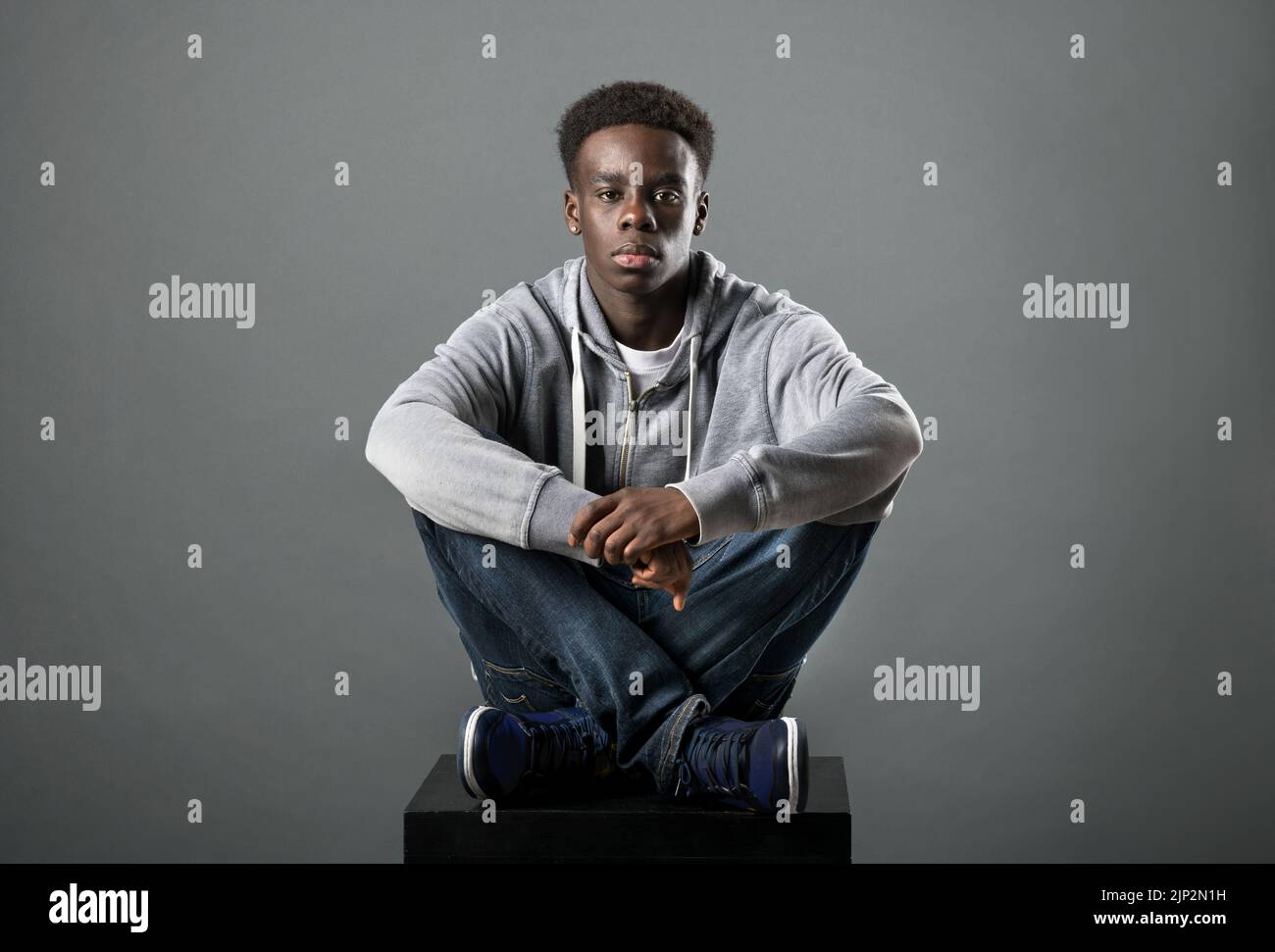 young man, serious, cross-legged, person of color, guy, man, men, young ...