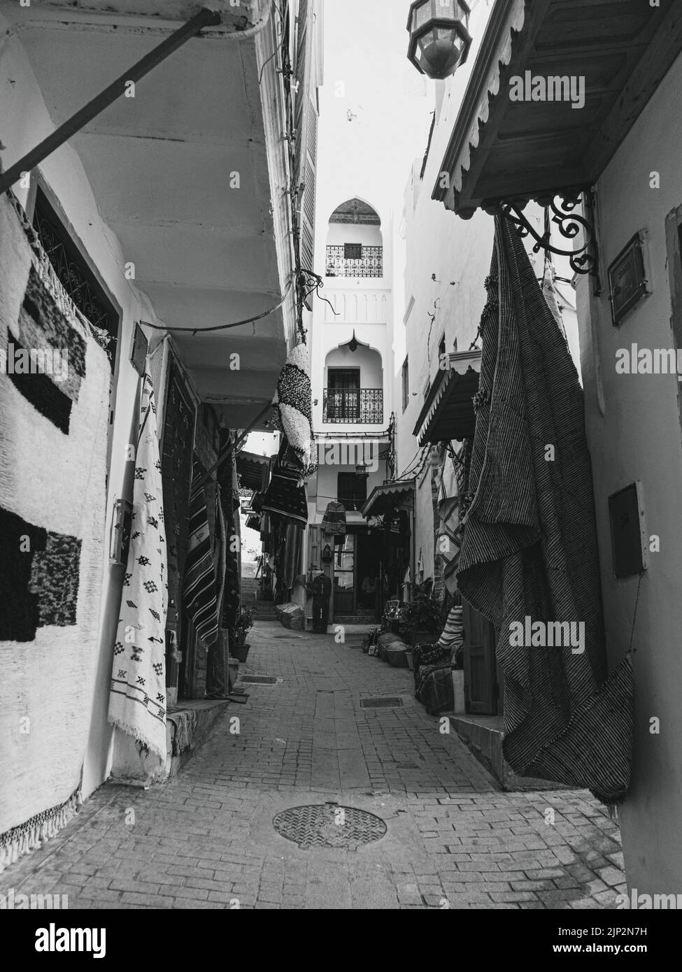 A vertical shot of a street in grayscale in the old Medina at Tanger in ...