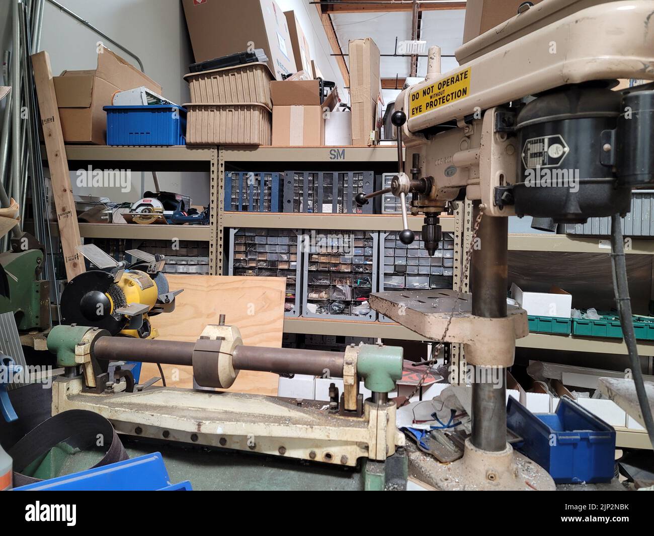 An interior of a factory with cluttered workbench and shelves Stock ...